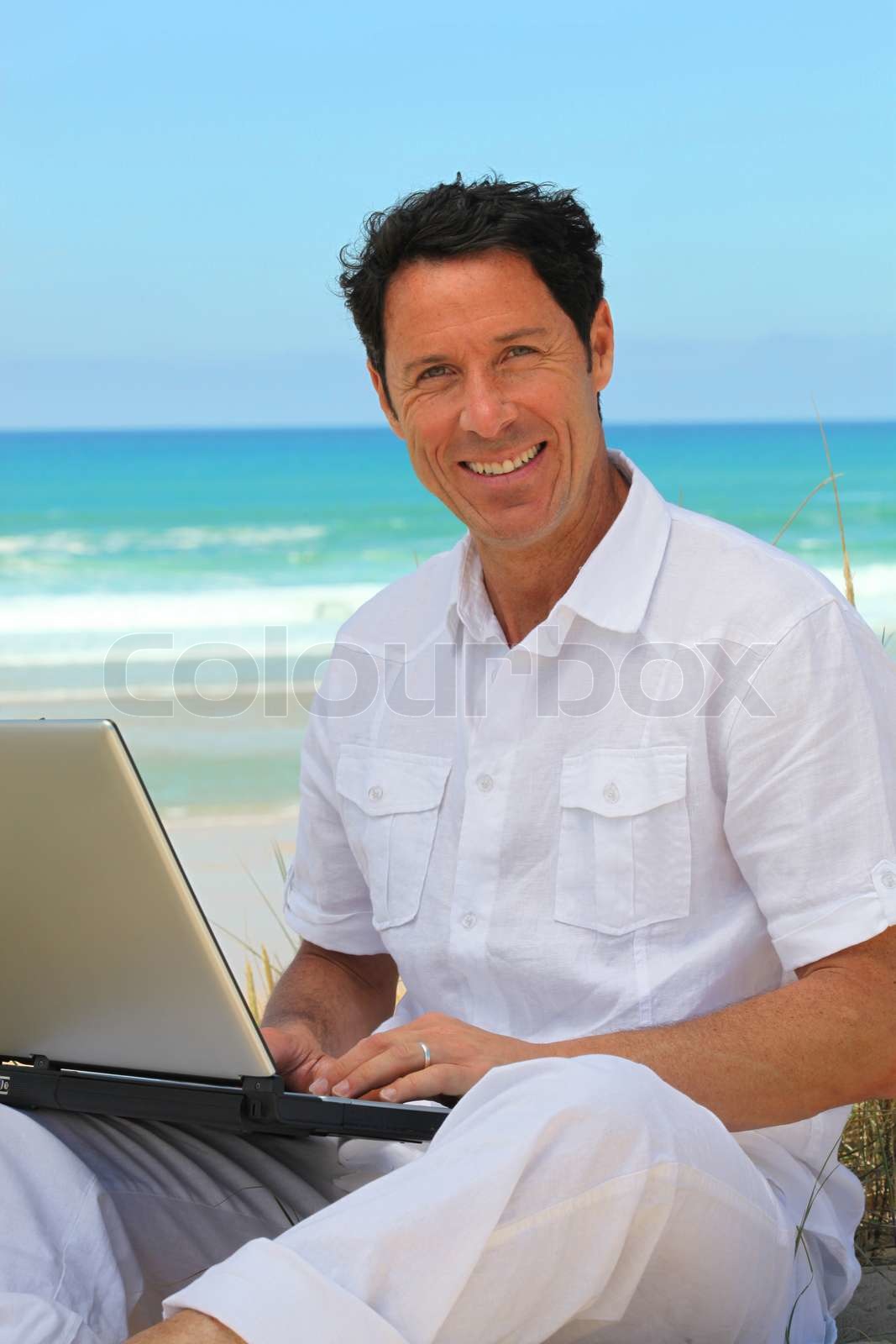 Man working on the beach. | Stock image | Colourbox