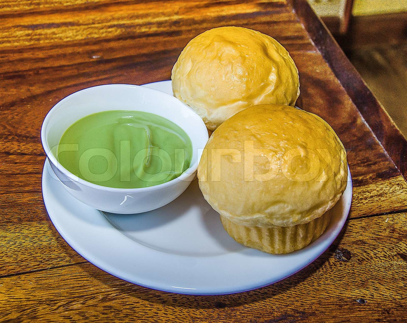 Stream bread dipping with egg custard | Stock image | Colourbox