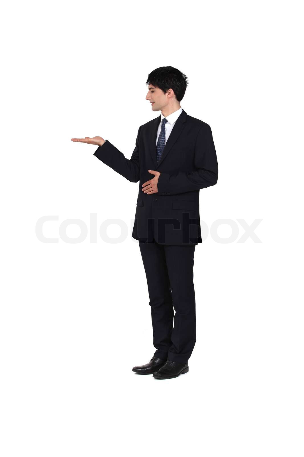 Man wearing a suit and presenting his right hand | Stock image | Colourbox