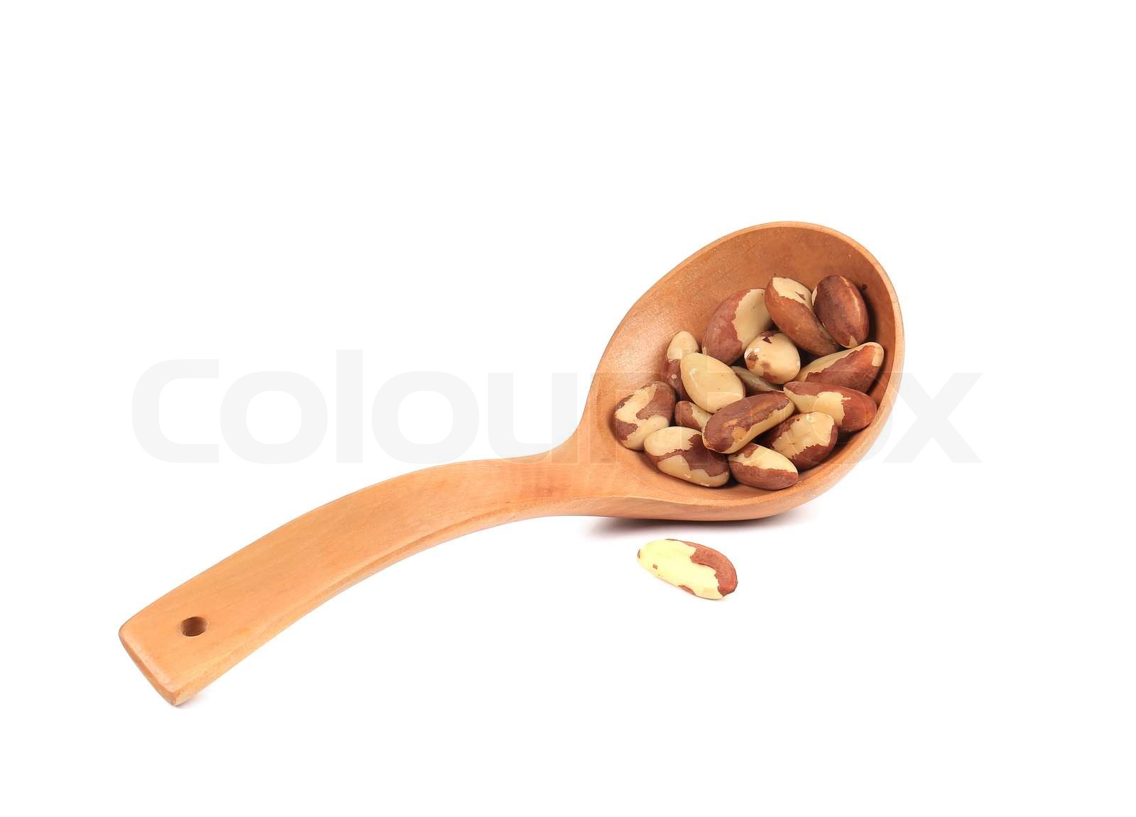 Wooden spoon with brazil nuts. | Stock image | Colourbox