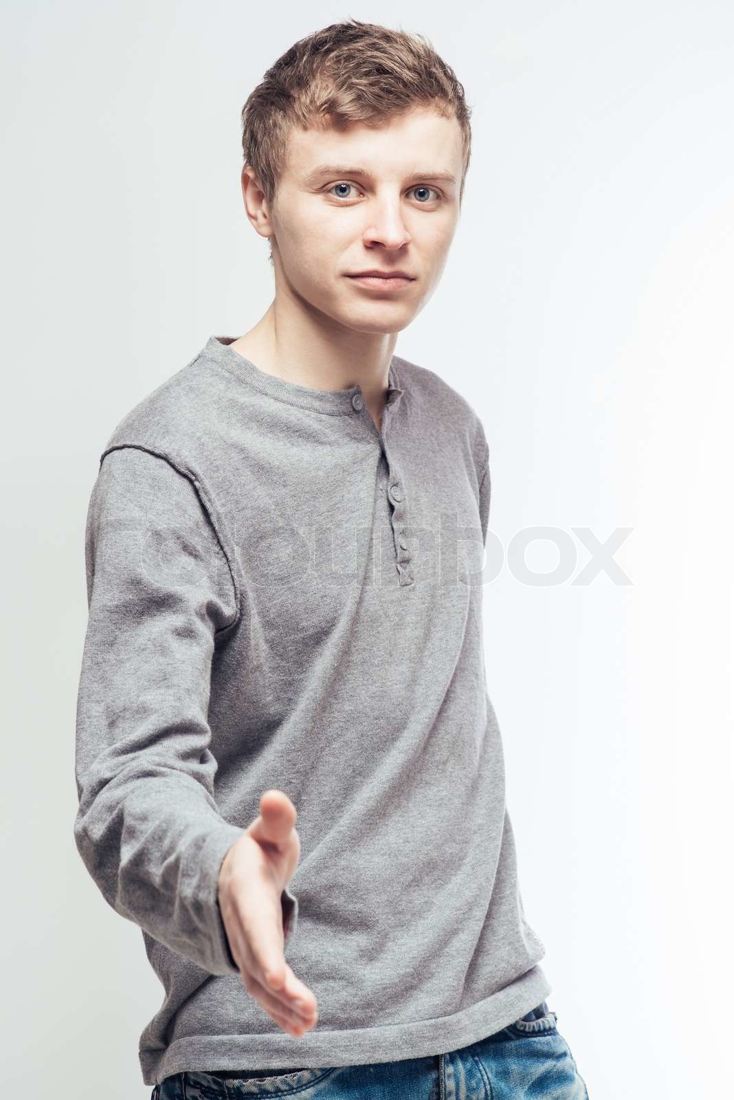 Man stretches out his hand for a handshake | Stock image | Colourbox