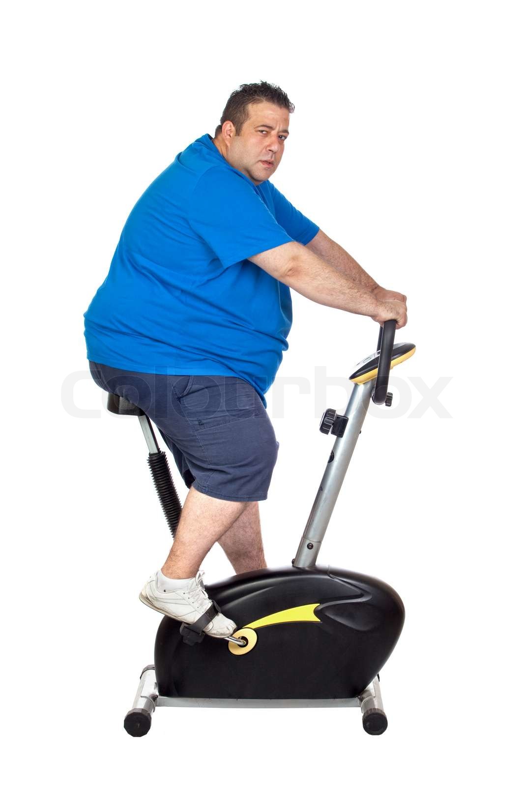 Fat Man in a Static Bicycle | Stock image | Colourbox