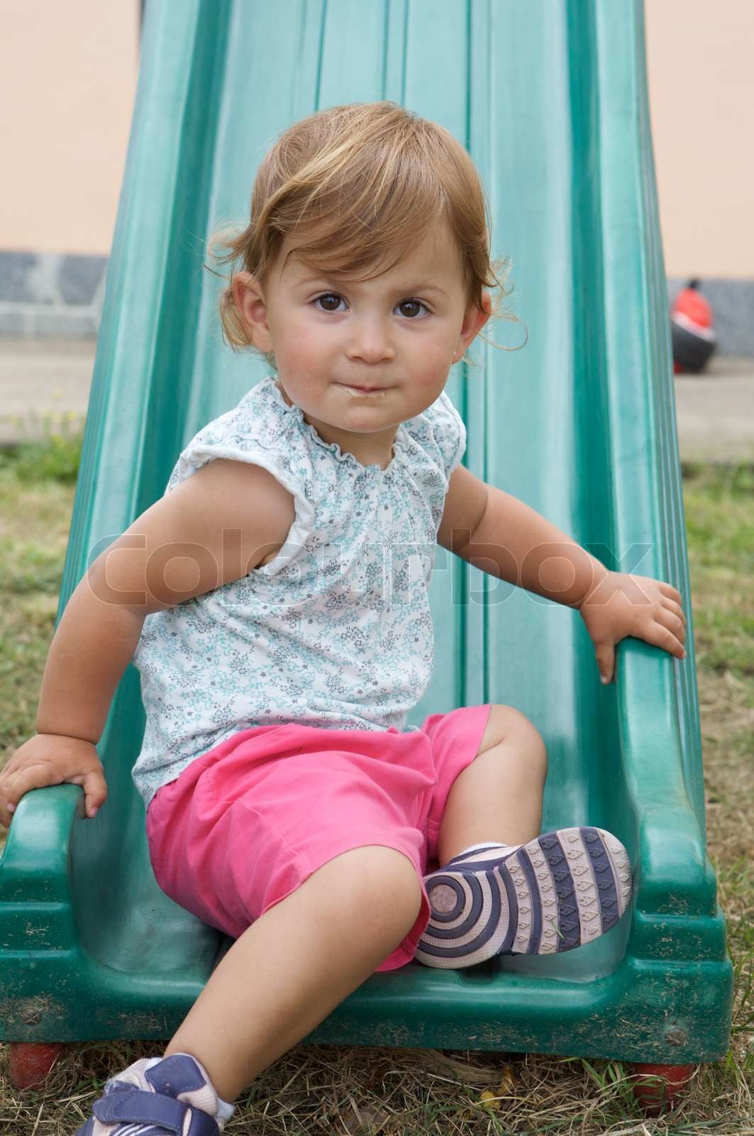 Girl playing on a slide | Stock image | Colourbox