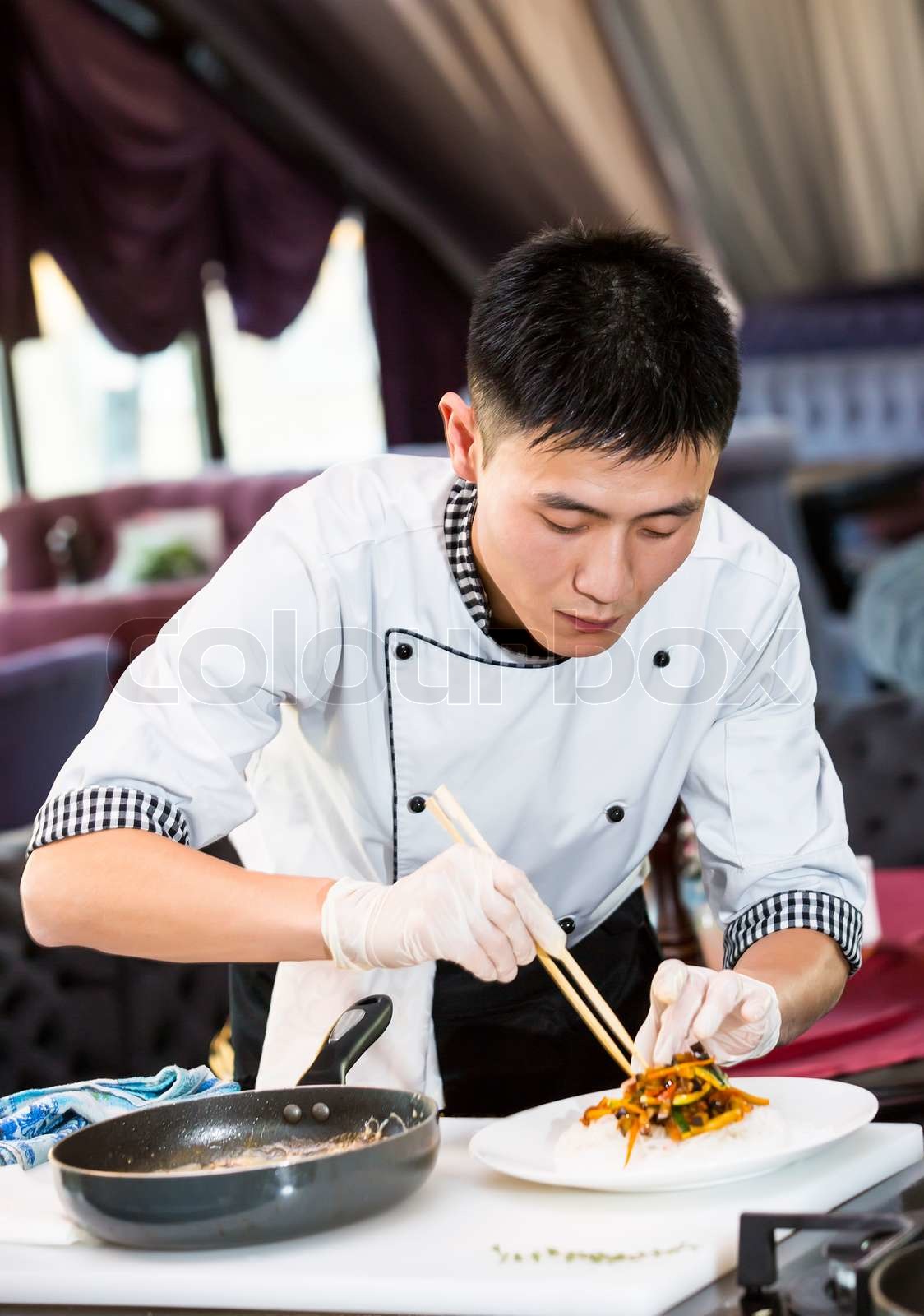 Japanese chef preparing a meal in a restaurant | Stock image | Colourbox