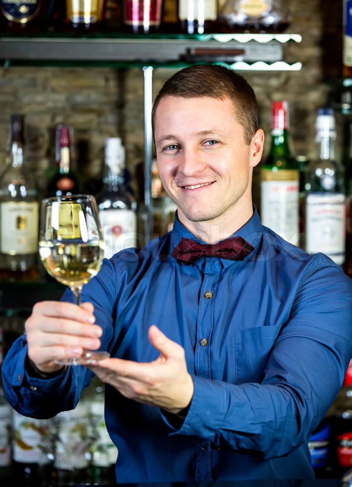 young man working as a bartender in a nightclub bar | Stock image ...