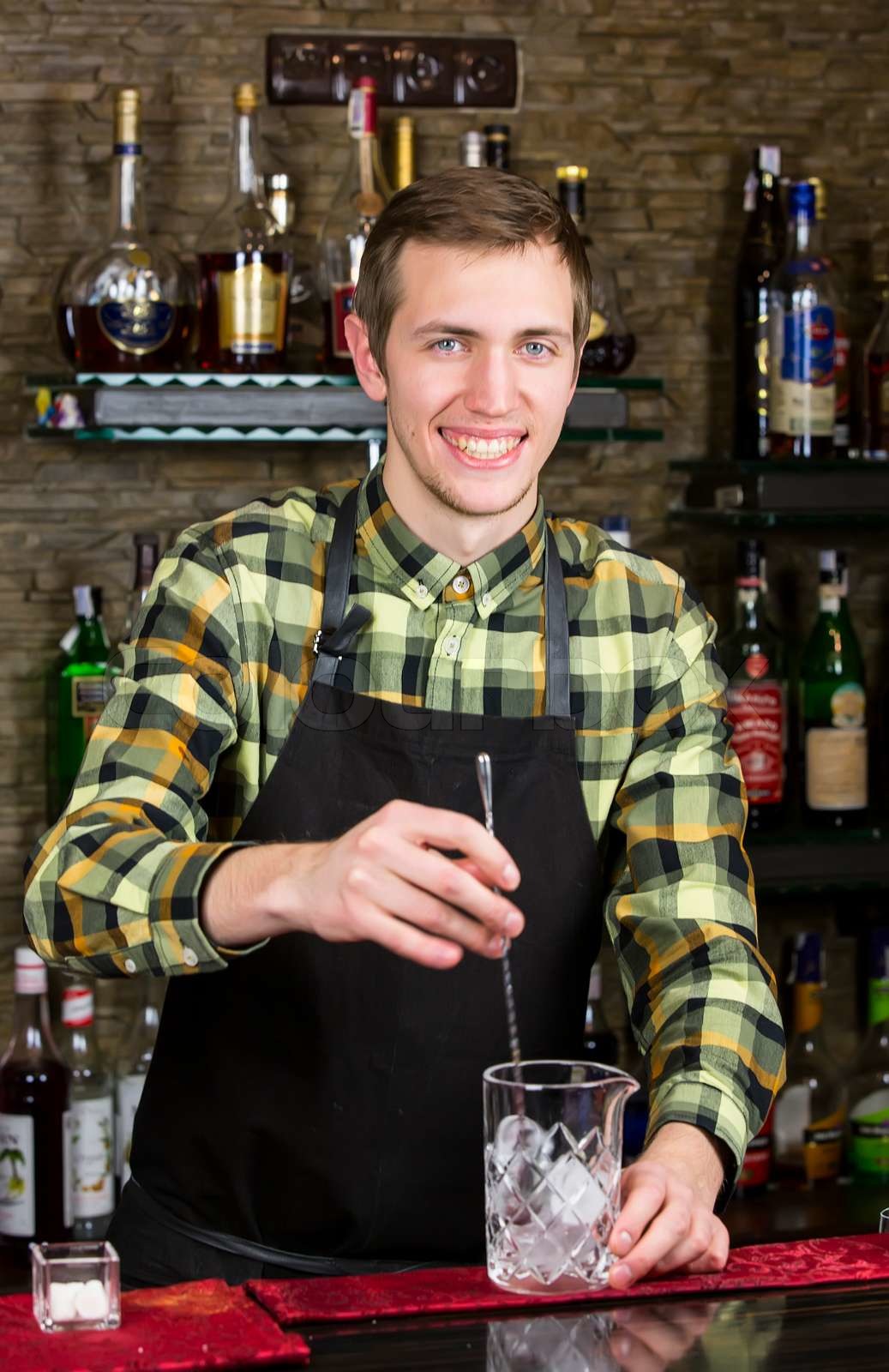 young man working as a bartender in a nightclub bar | Stock image ...