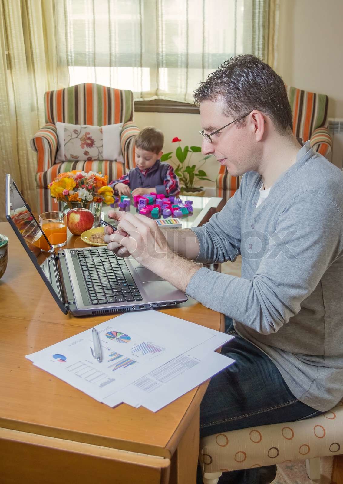 Father working in home office and son playing | Stock image | Colourbox