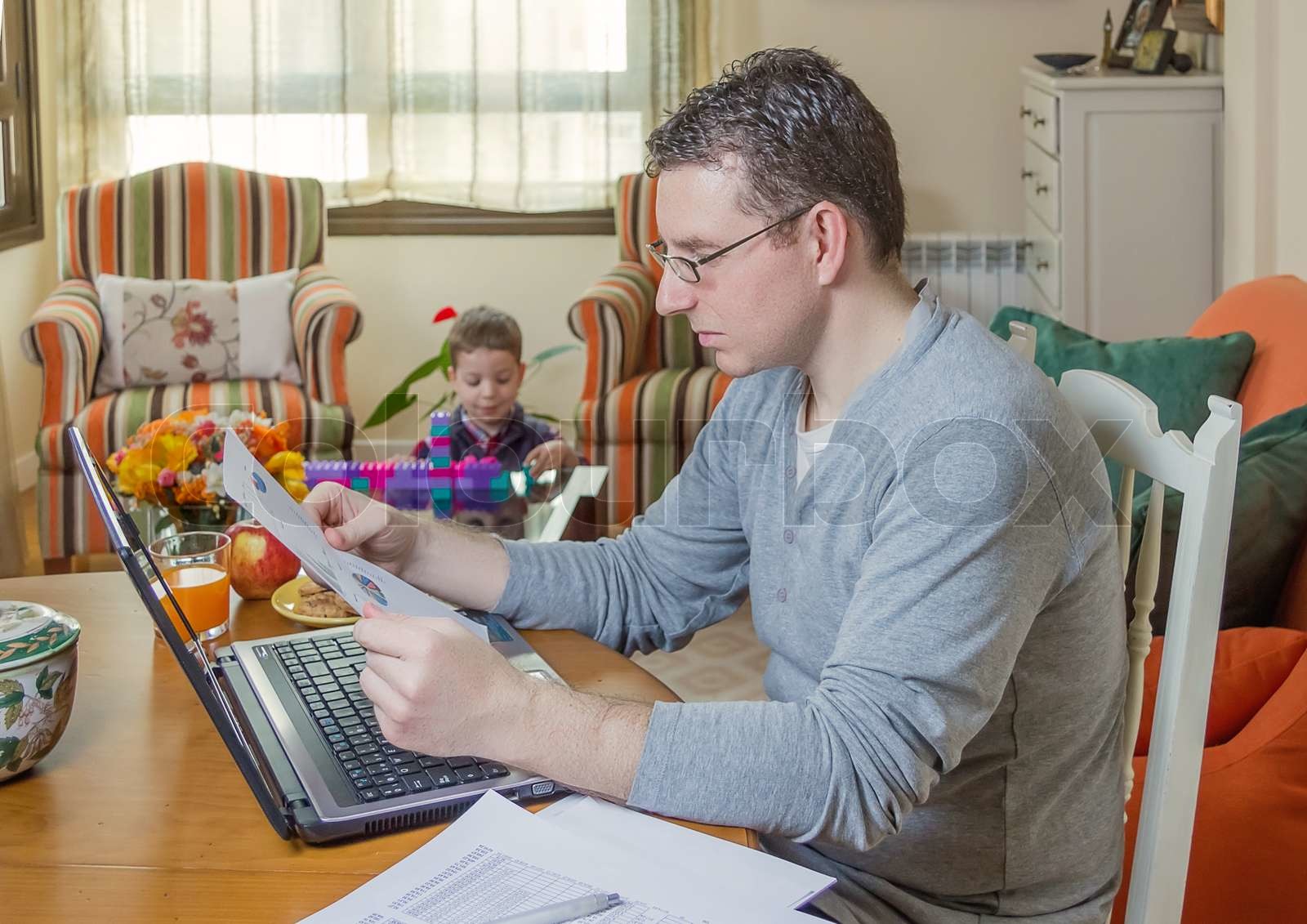 Father working in home office and son playing | Stock image | Colourbox