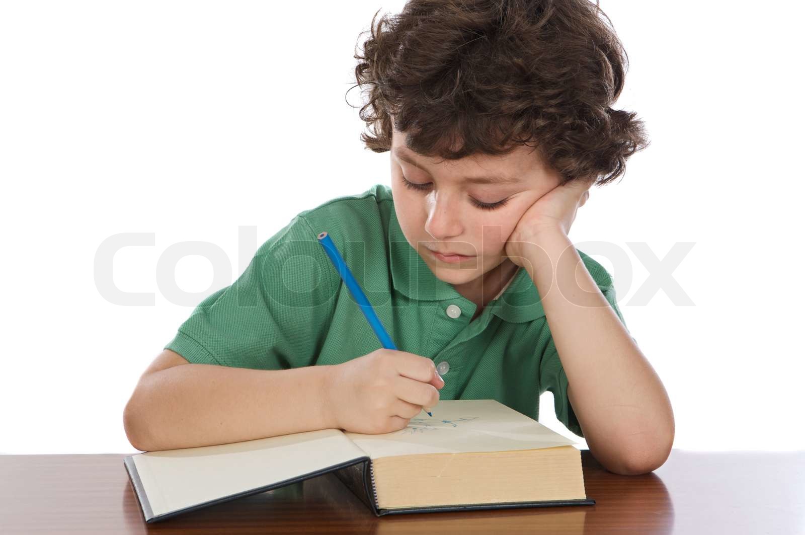 Adorable child write in book | Stock image | Colourbox