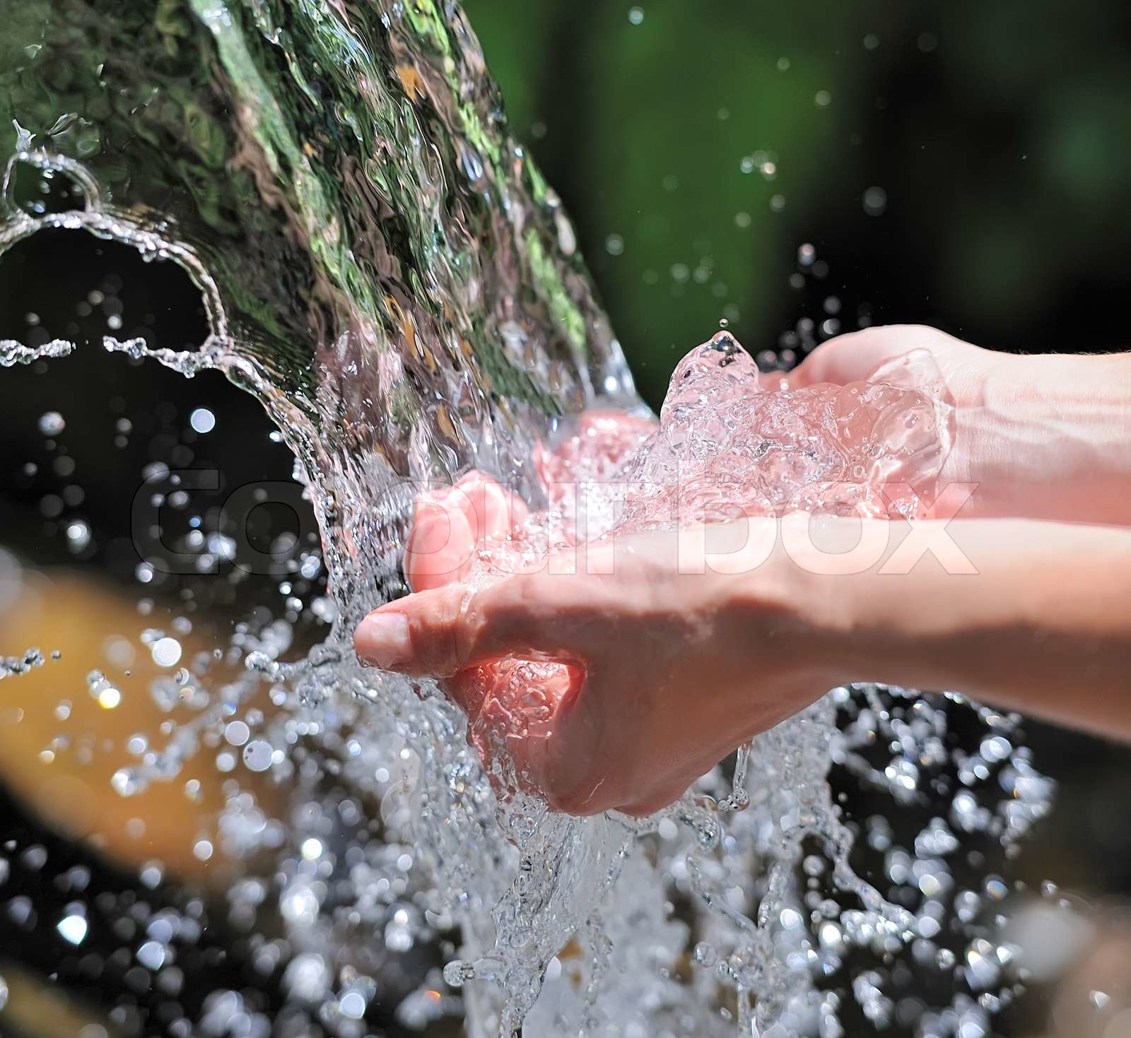 Woman's hands with water splash | Stock image | Colourbox