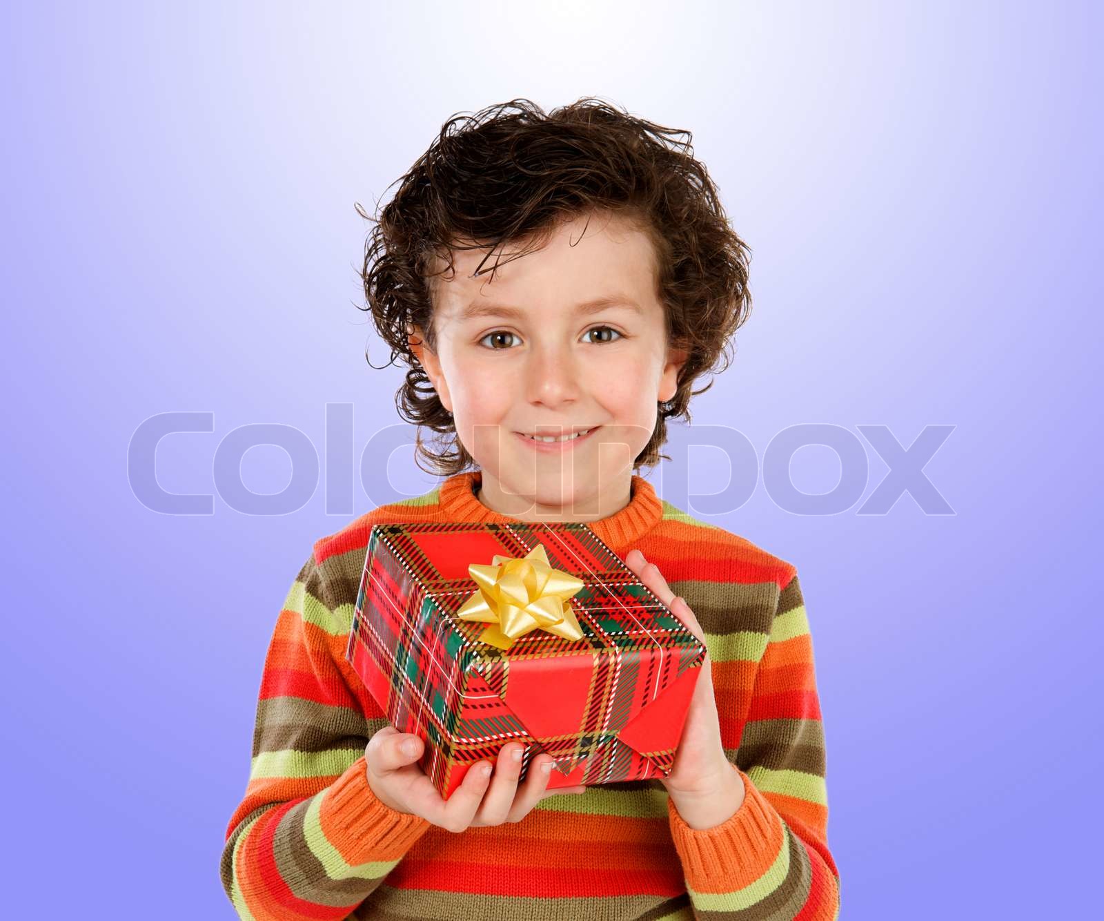 Beautiful child giving a present | Stock image | Colourbox