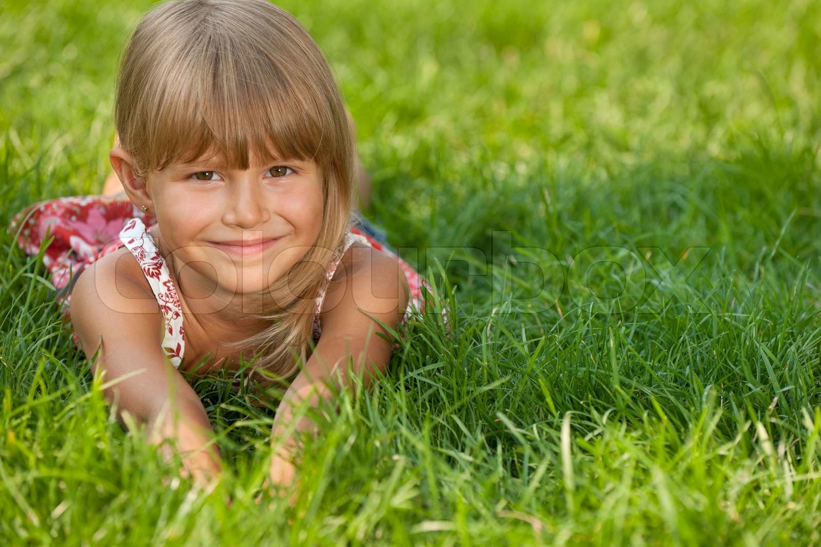 Joyful little girl on the grass | Stock image | Colourbox