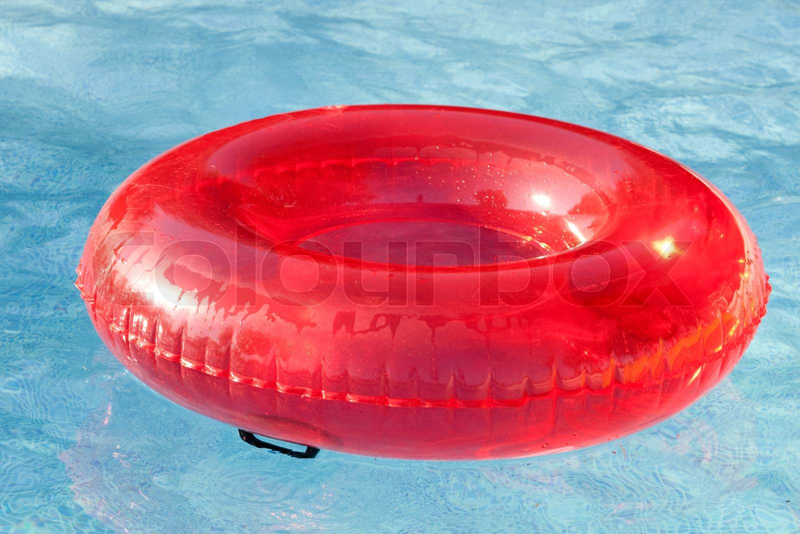 Red float floating in the pool | Stock image | Colourbox