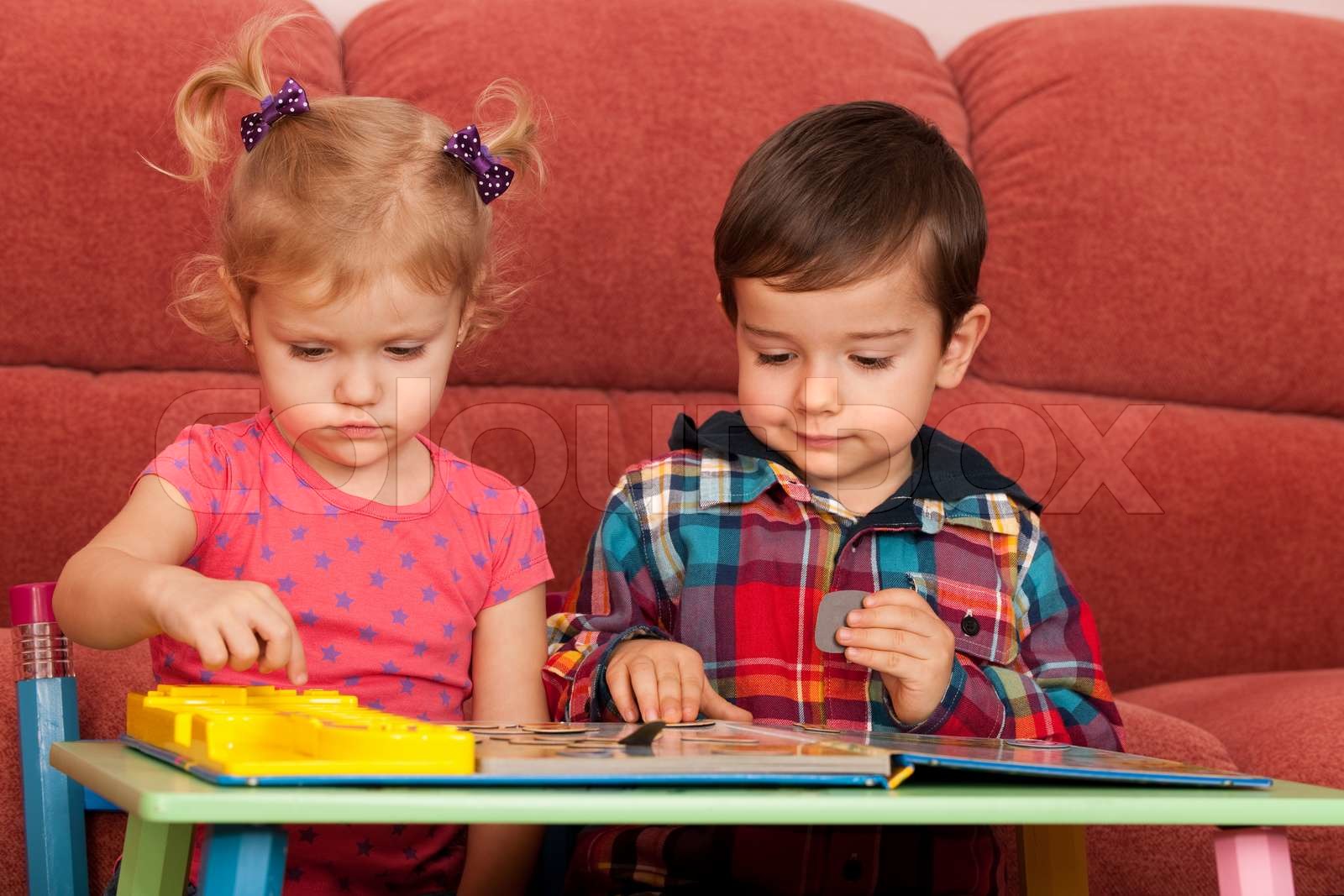 Children playing at the table | Stock image | Colourbox