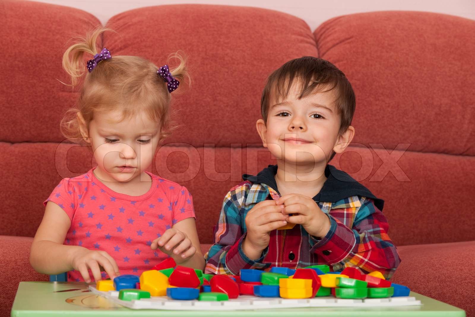 Two children playing at the table | Stock image | Colourbox