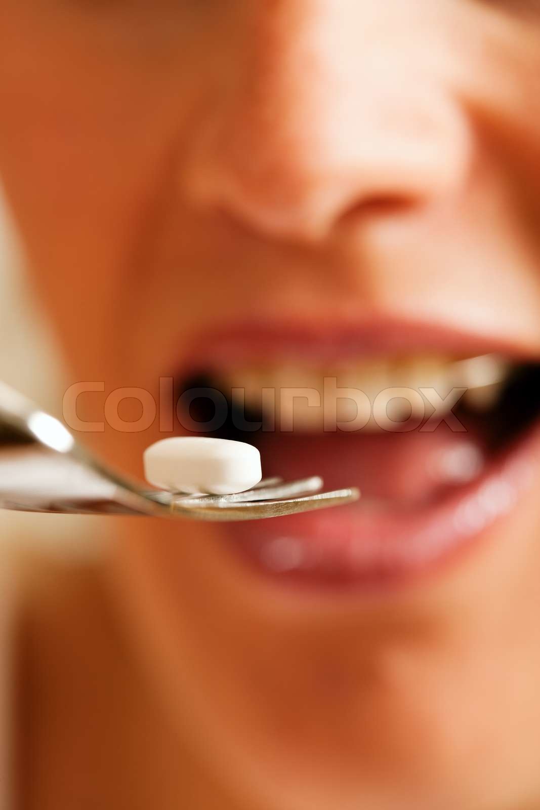Woman eating nutritional supplements | Stock image | Colourbox