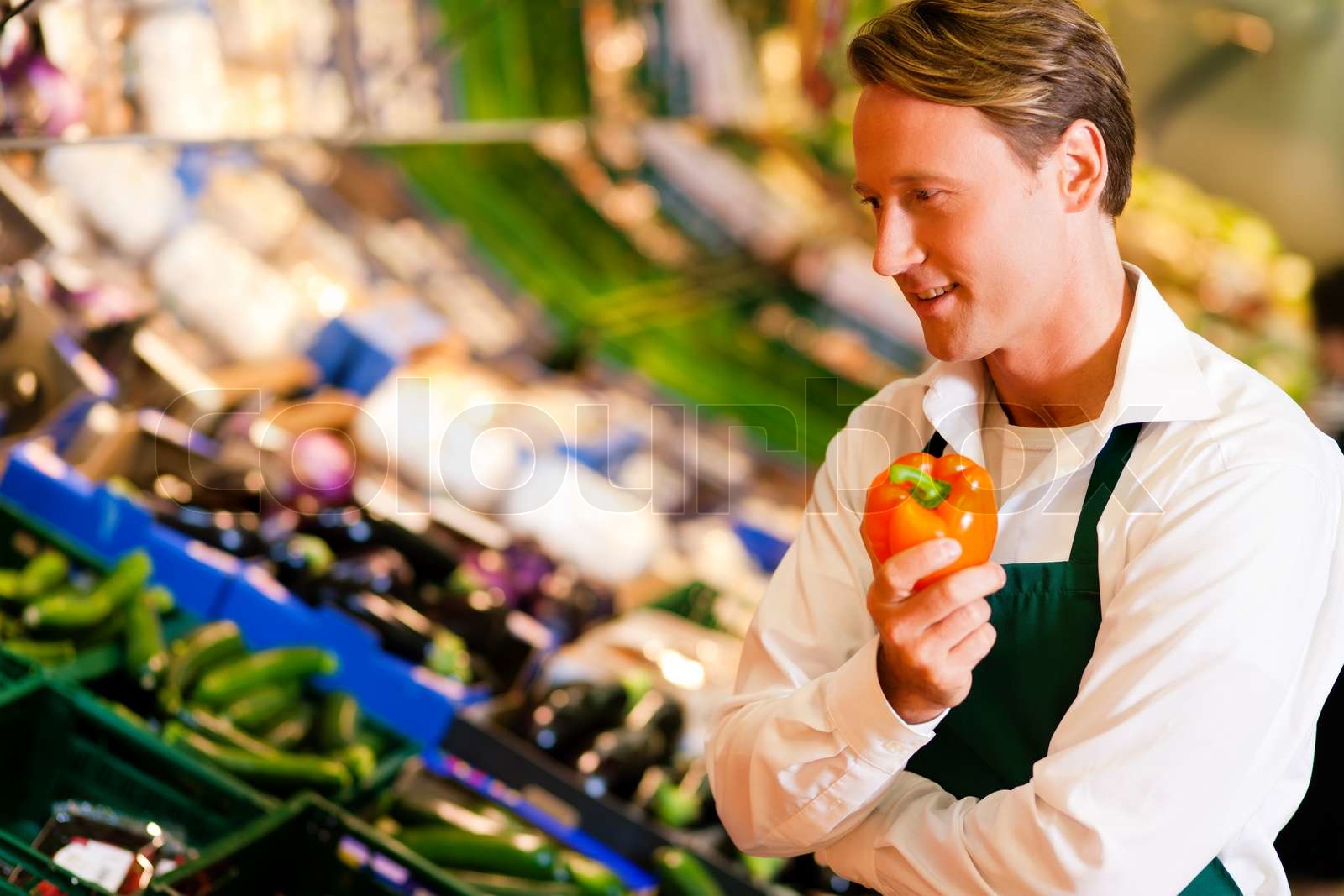 Man in supermarket as shop assistant | Stock image | Colourbox