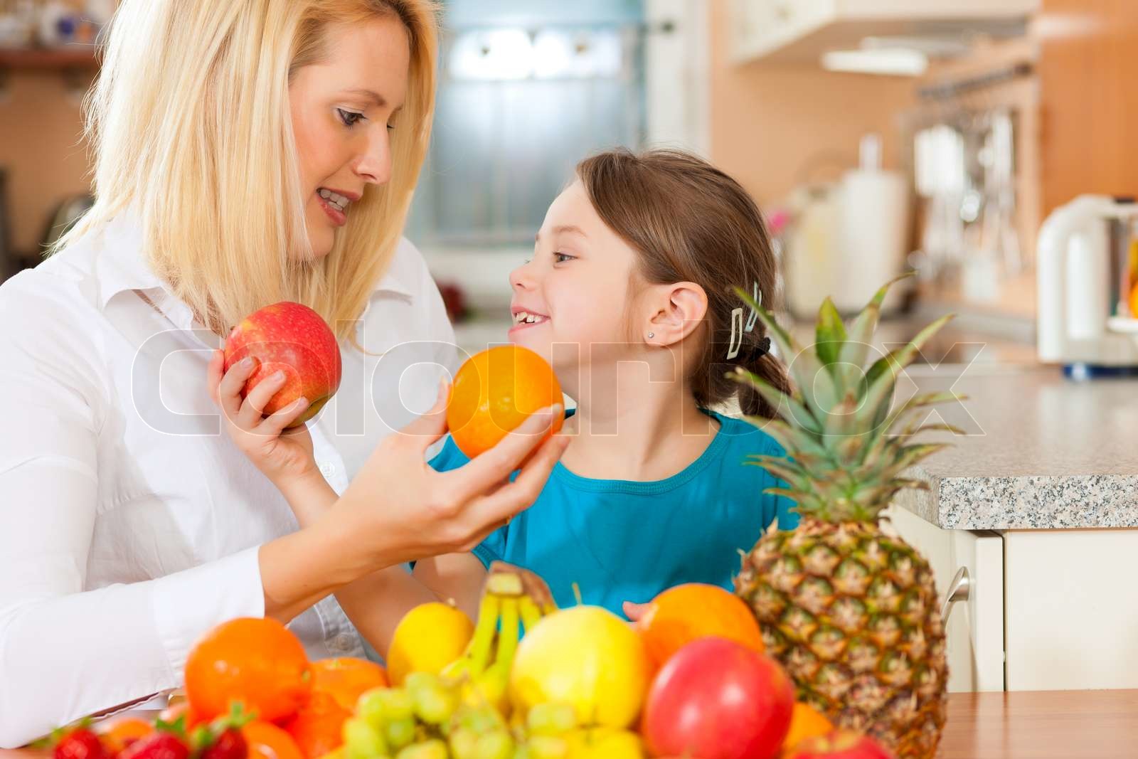 Mother and child with lots of fruits | Stock image | Colourbox
