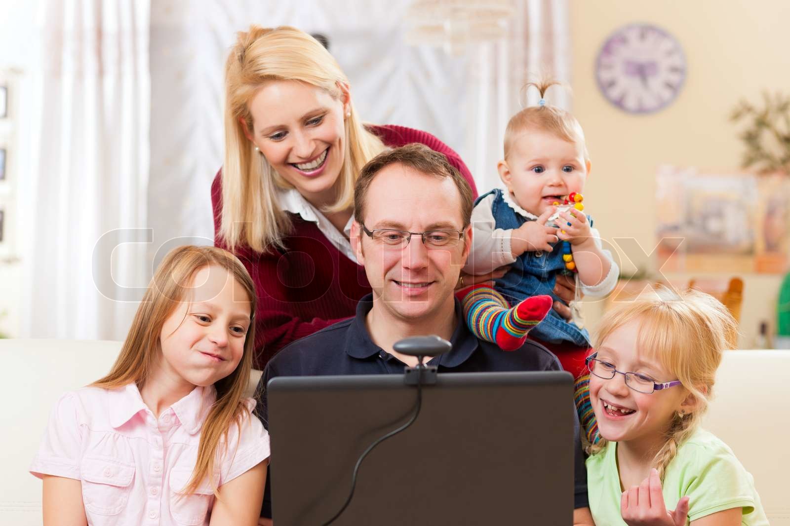 Family with computer having video conference | Stock image | Colourbox