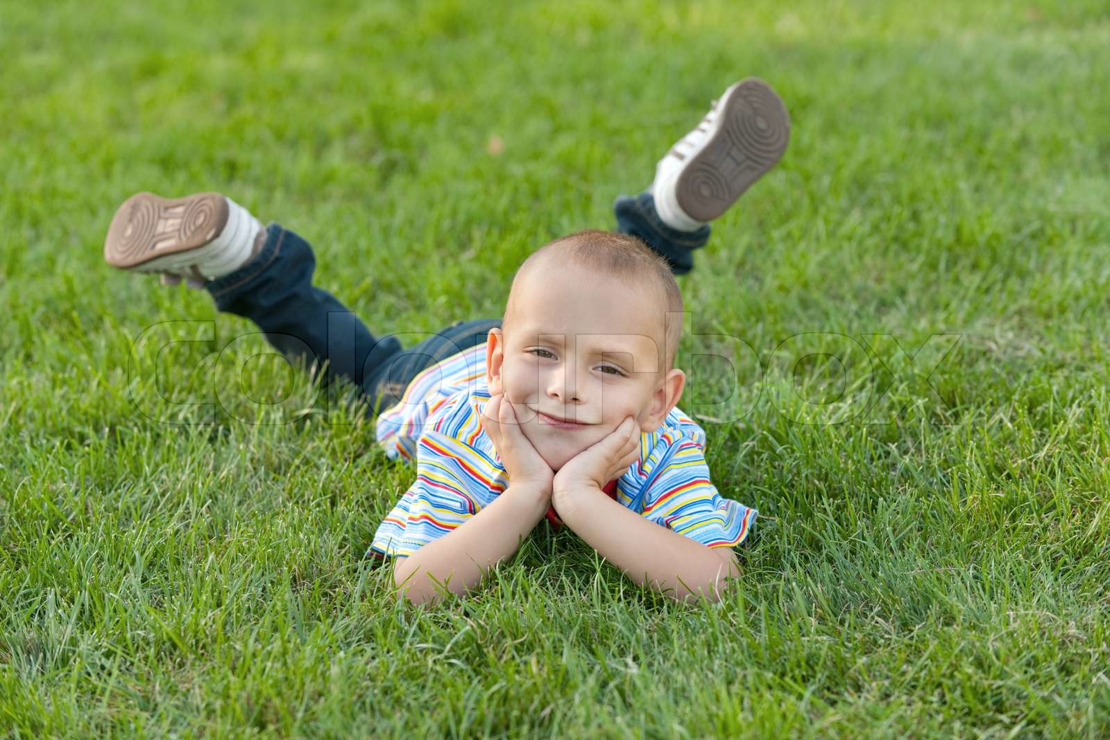 Kid on the grass | Stock image | Colourbox