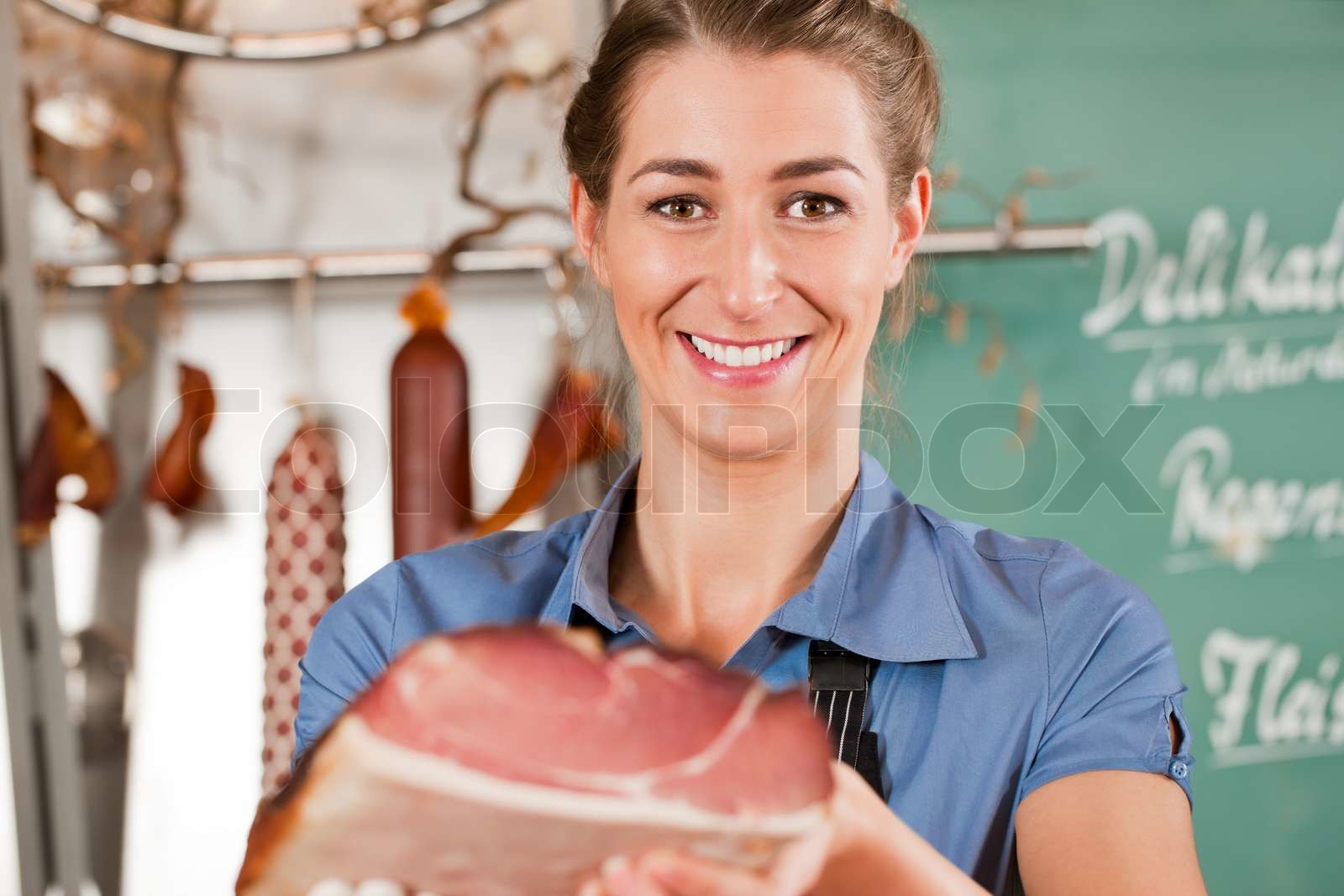 Woman or female butcher with raw ham in butchers shop | Stock image ...