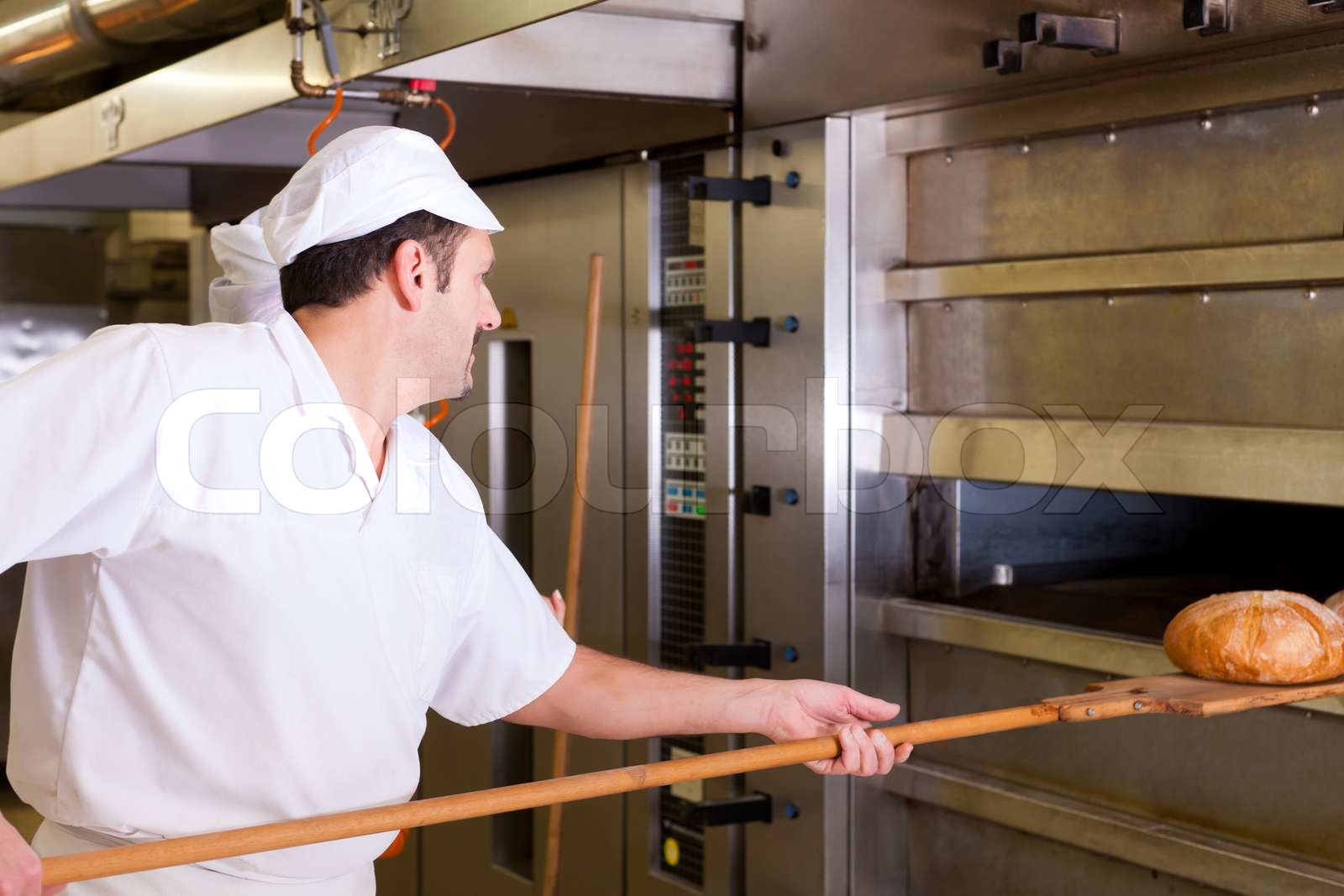 Male baker baking bread | Stock image | Colourbox