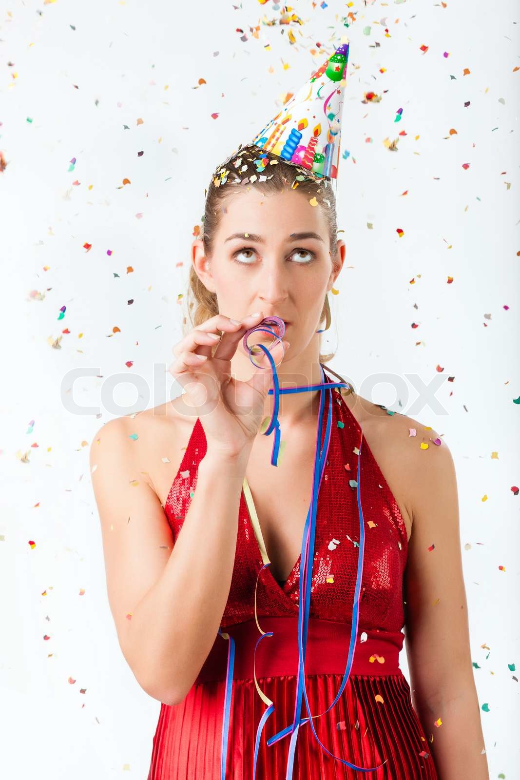 Woman at boring birthday party with streamer | Stock image | Colourbox