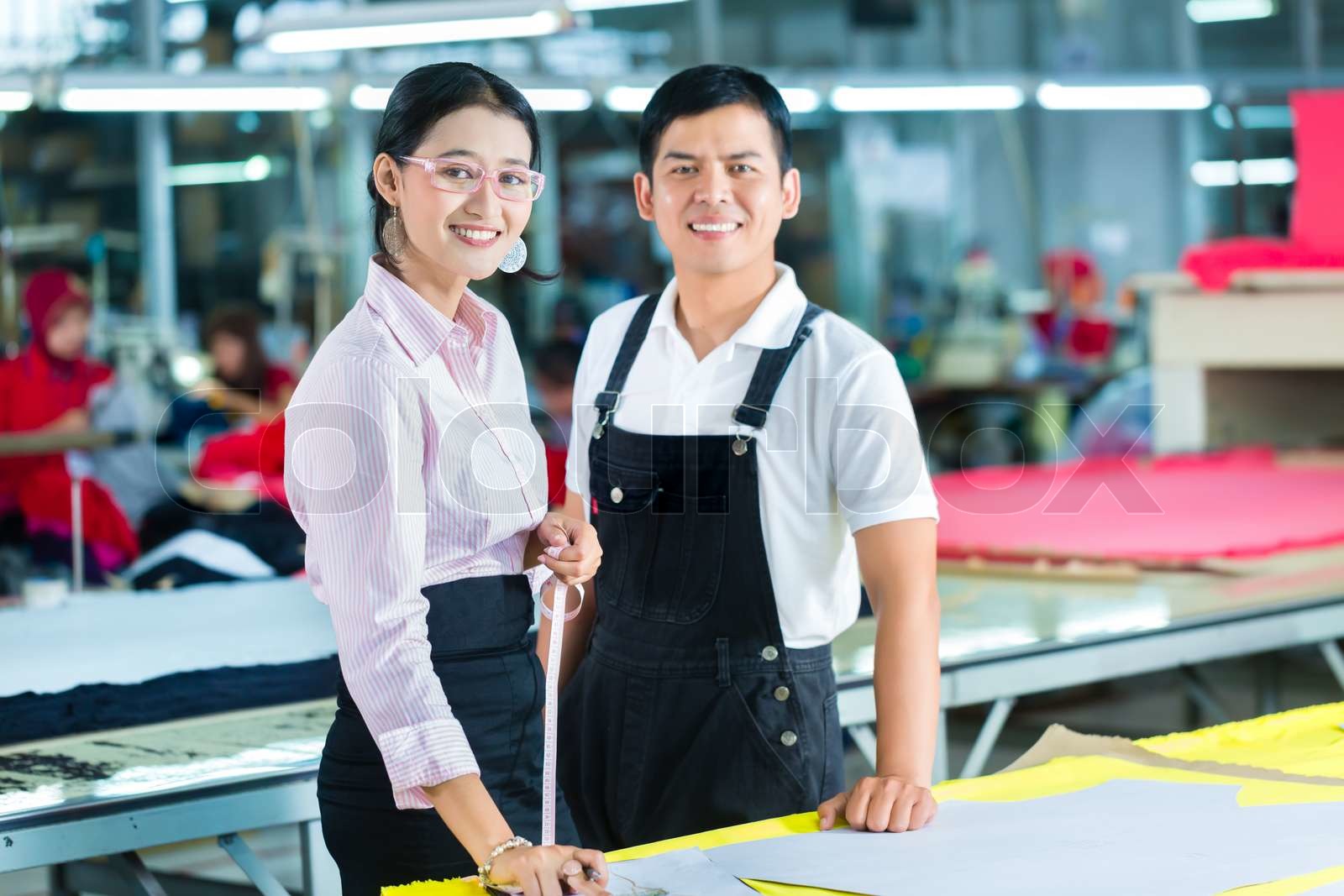 Production manager and designer in Asian factory | Stock image | Colourbox