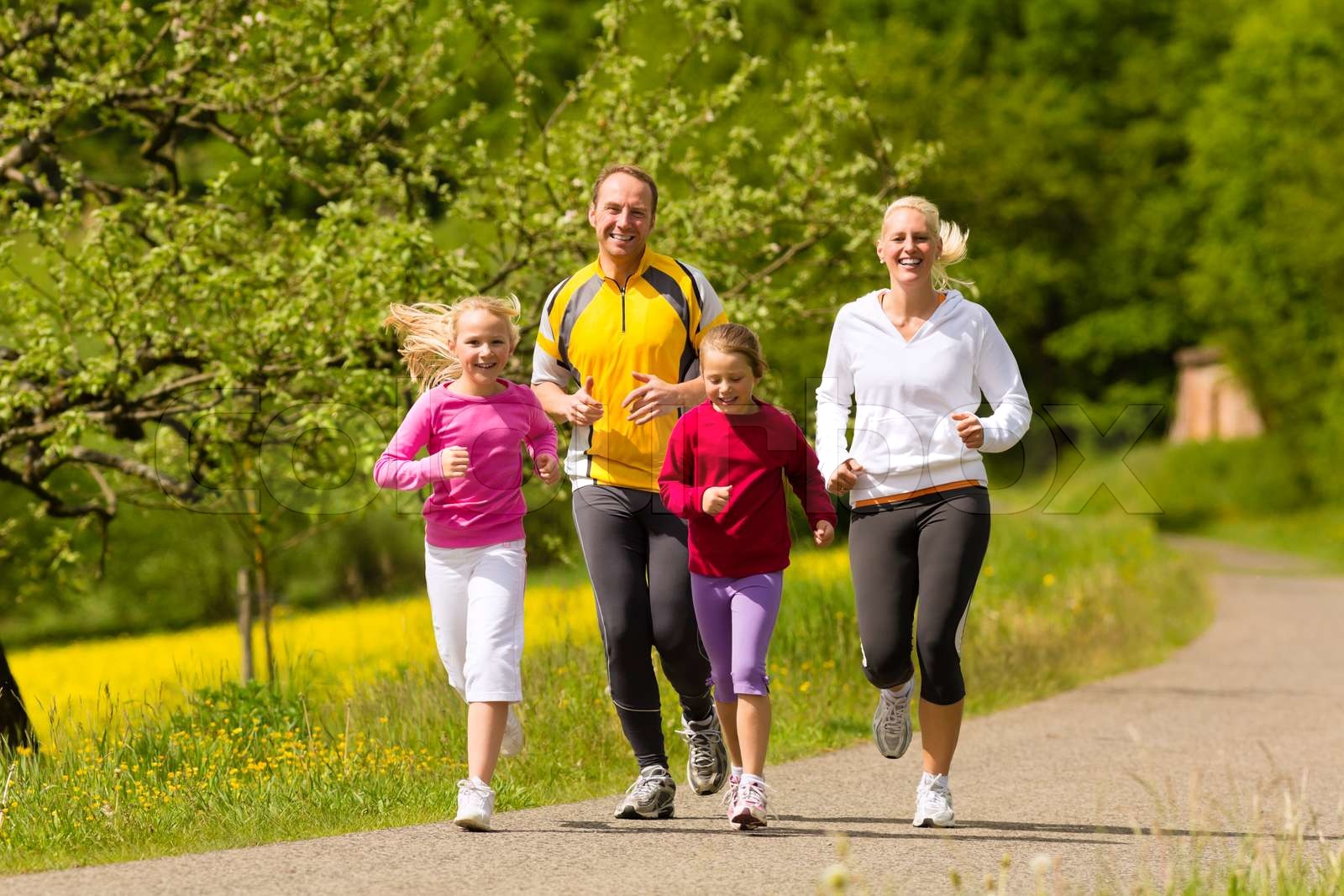 Family running in the meadow for sport | Stock image | Colourbox