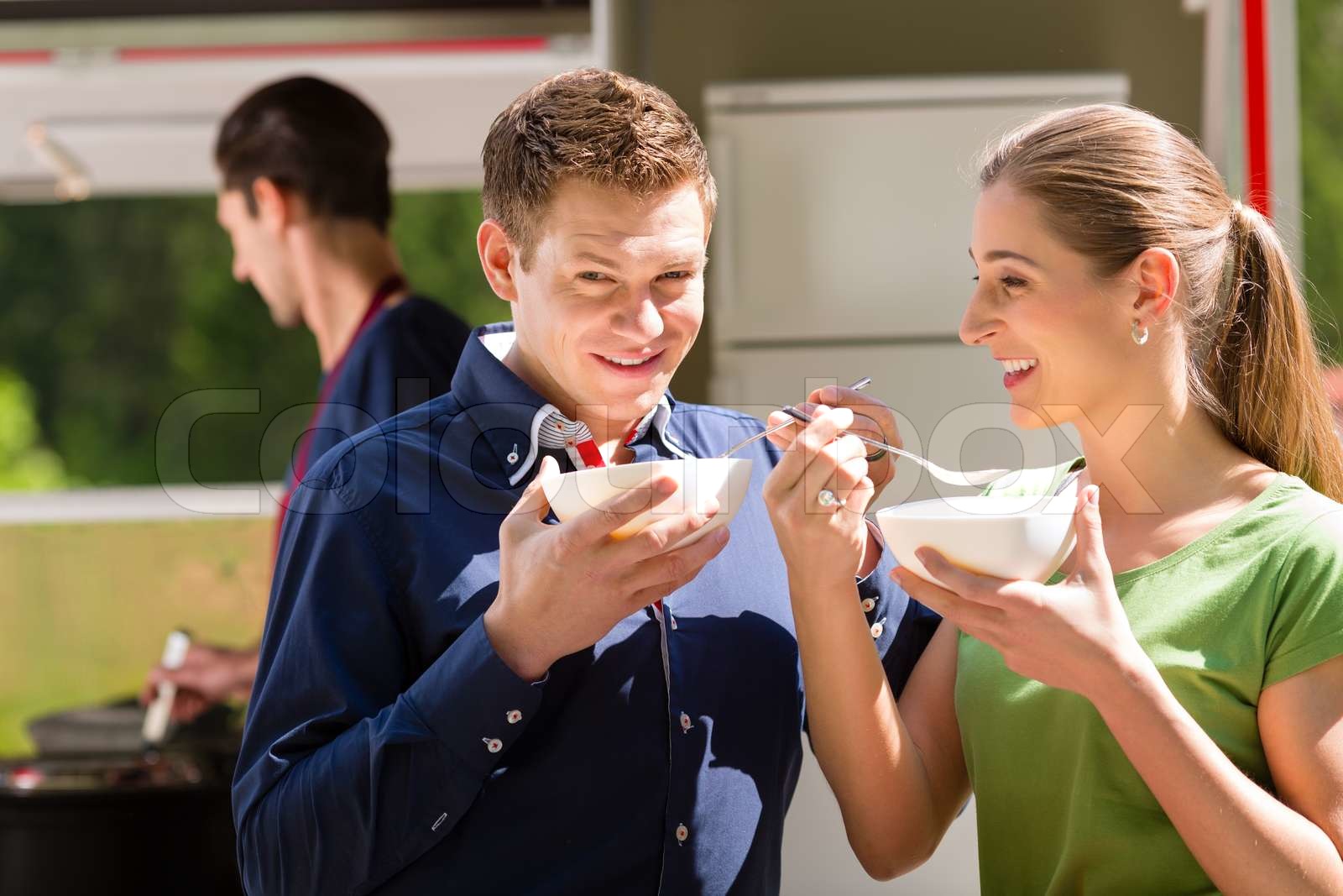 Friends eating a soup on the food stall | Stock image | Colourbox