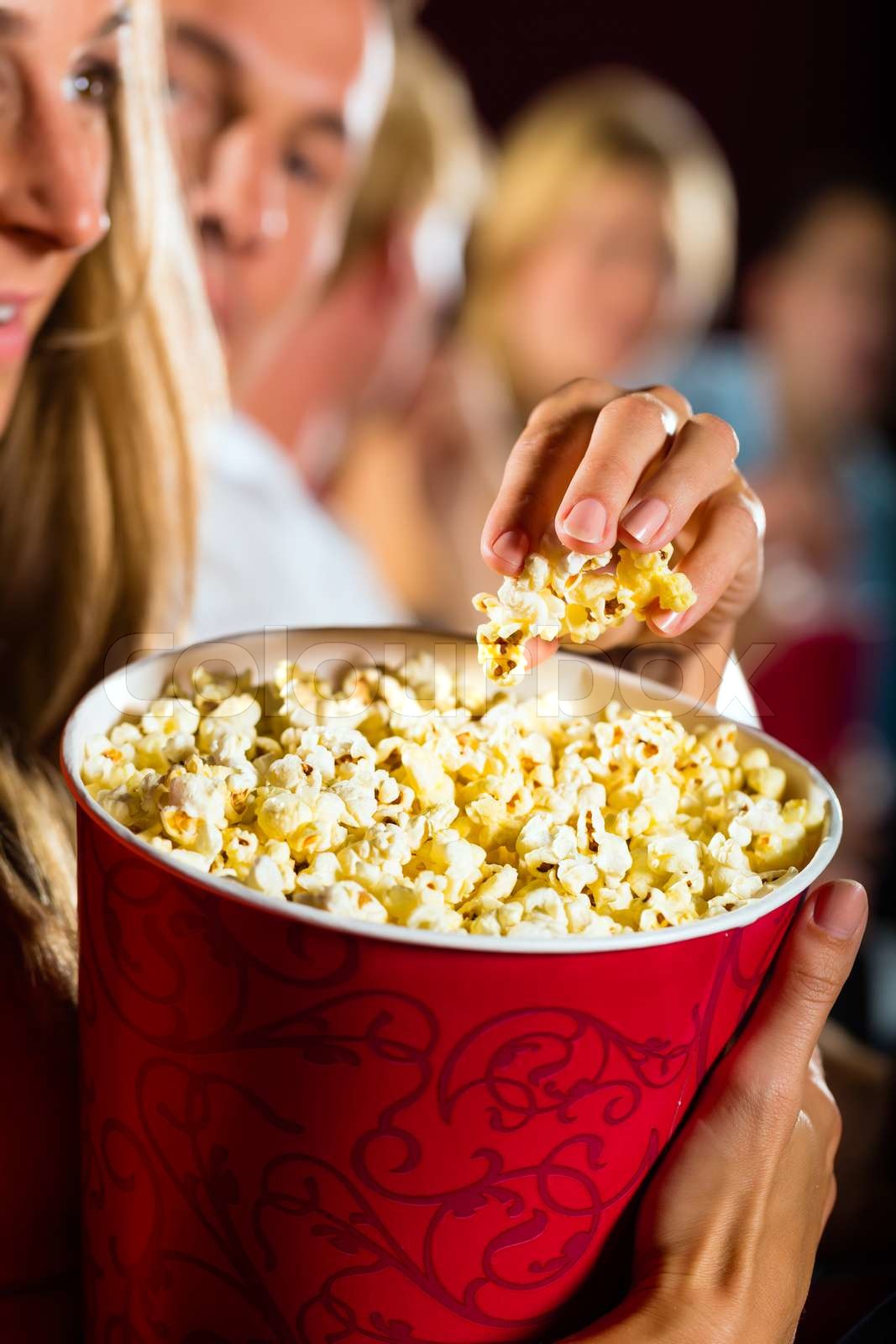 Girl eating popcorn in cinema or movie theater | Stock image | Colourbox