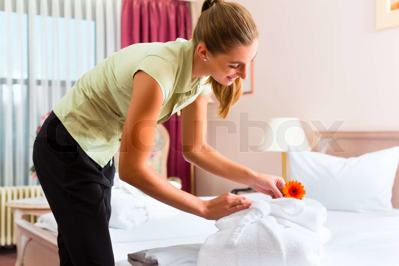 Maid doing room service in hotel | Stock image | Colourbox
