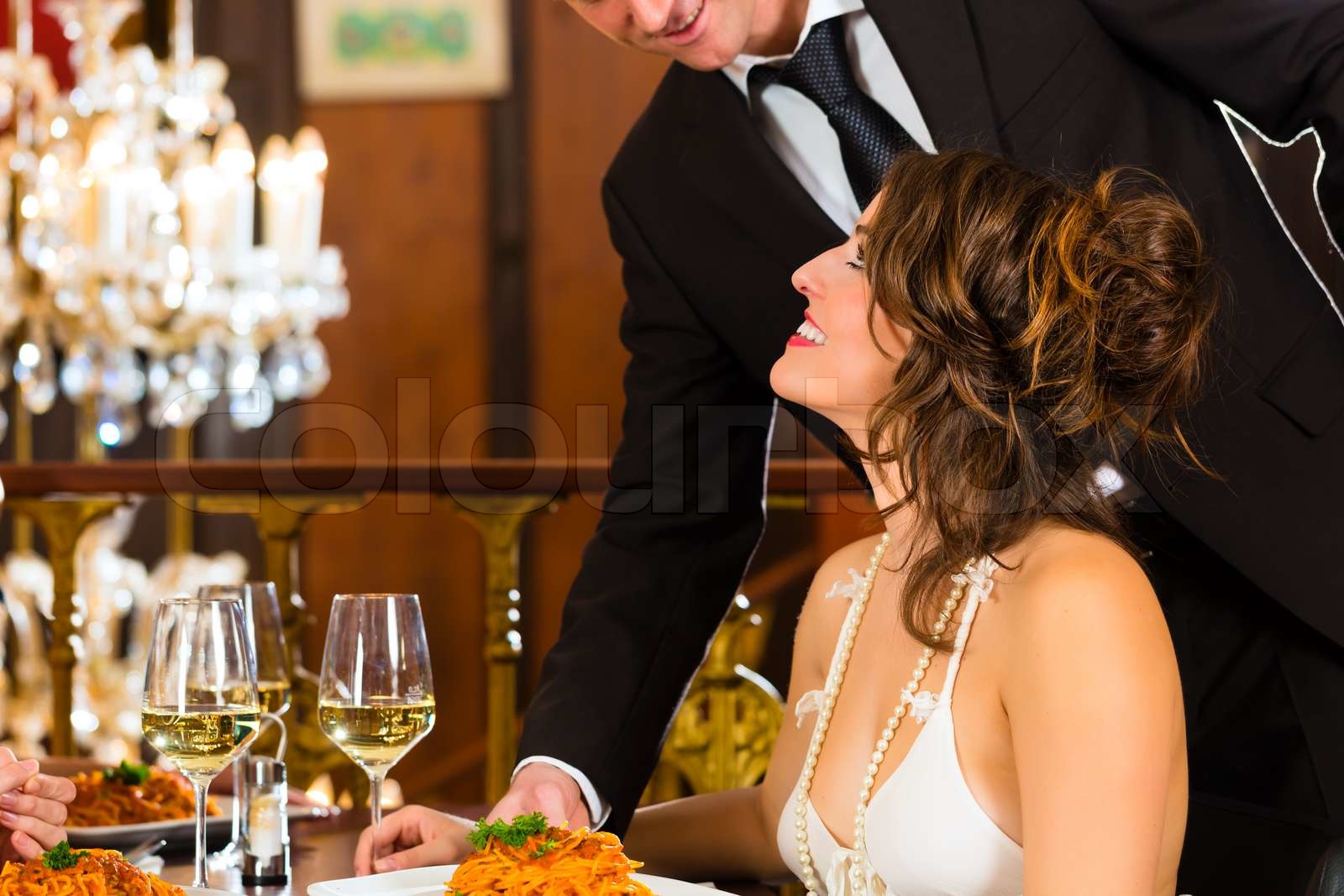 Beautiful woman and waiter in fine dining restaurant | Stock image ...