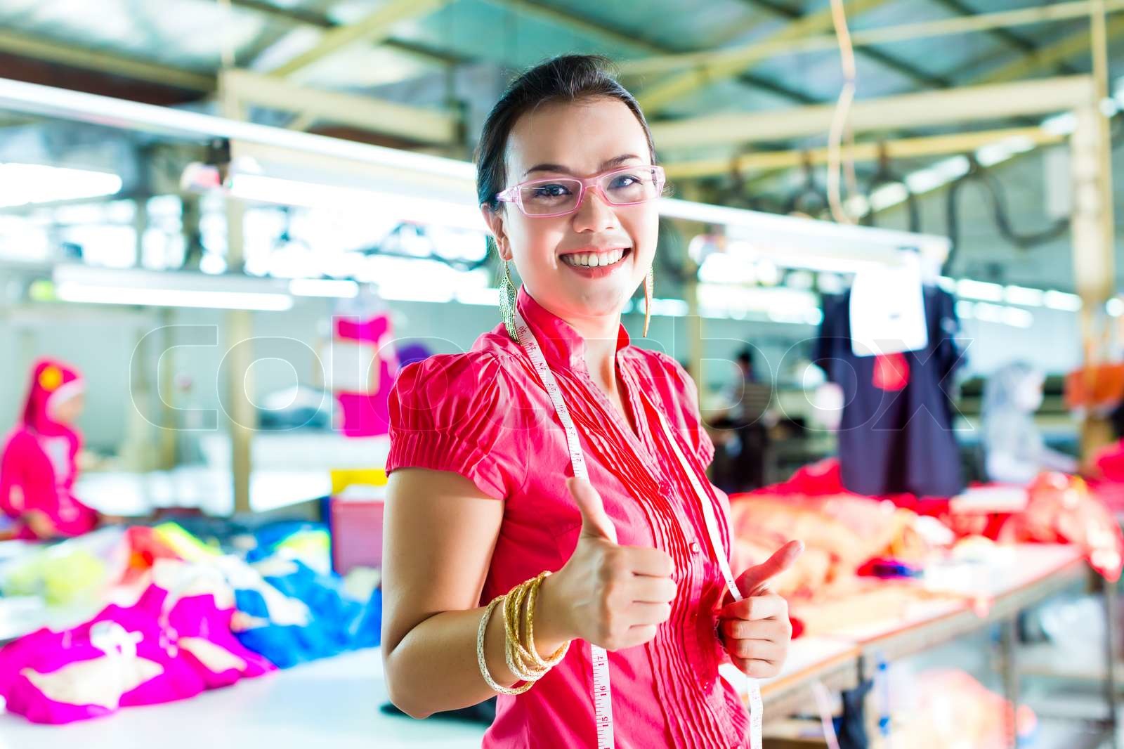 Asian dressmaker in a textile factory | Stock image | Colourbox