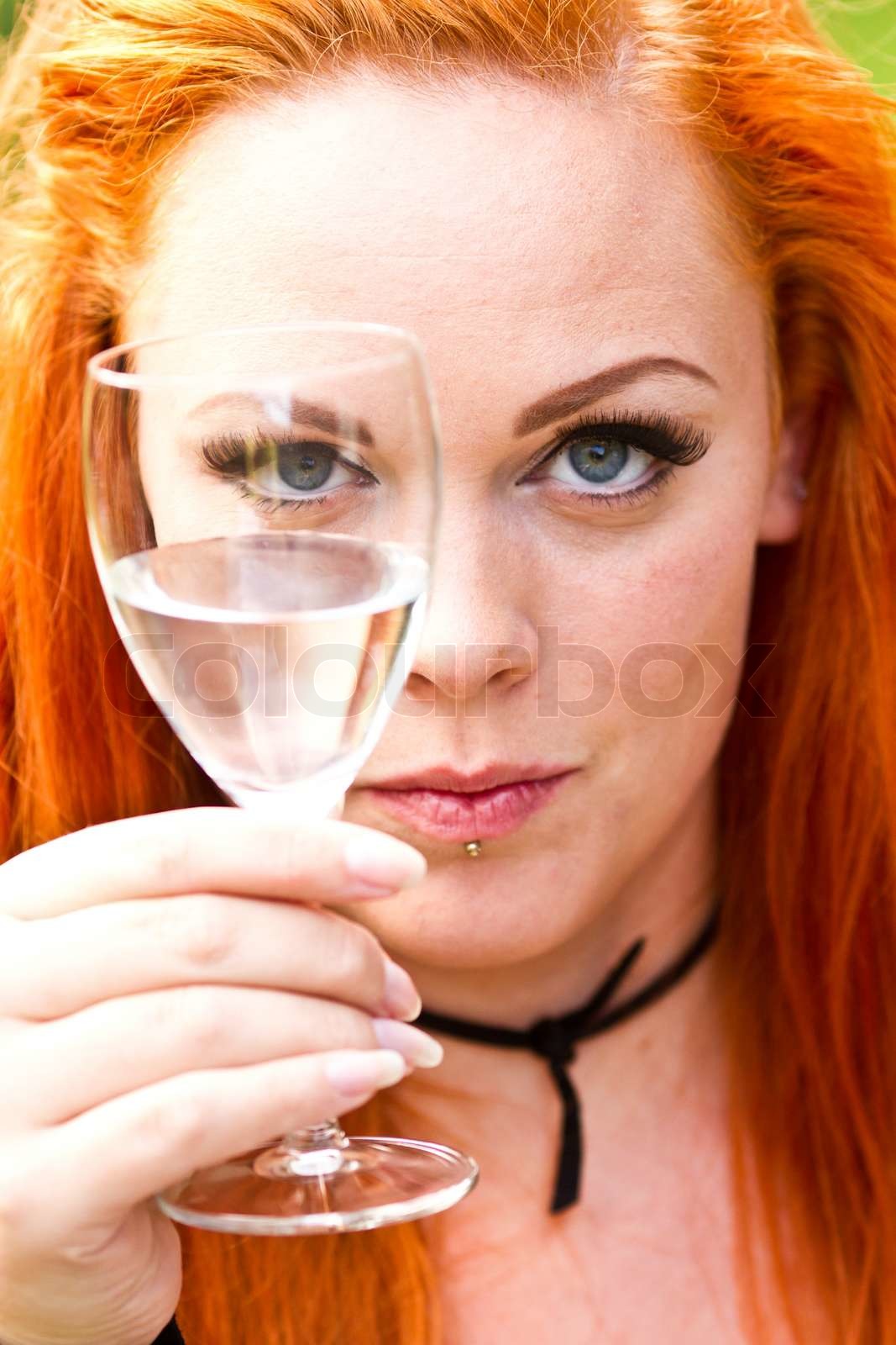 Red hair girl in pin-up style holding a glass of water | Stock image ...