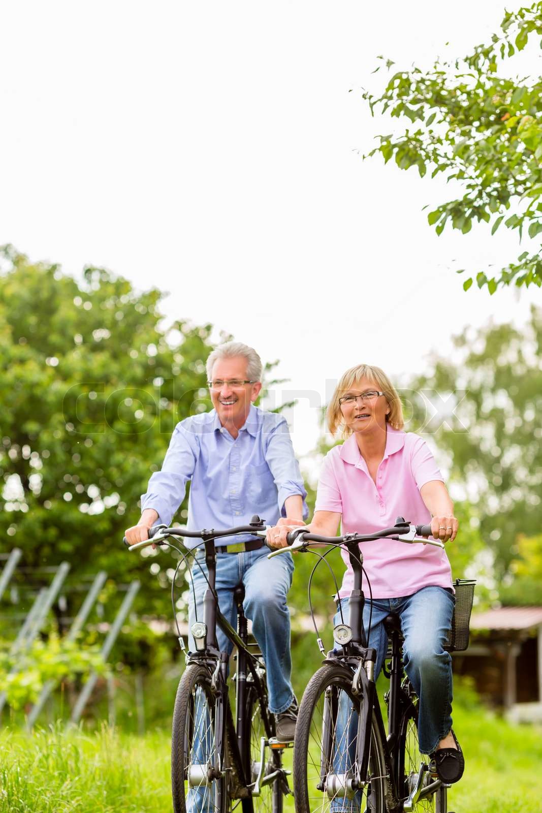 Seniors exercising with bicycle | Stock image | Colourbox