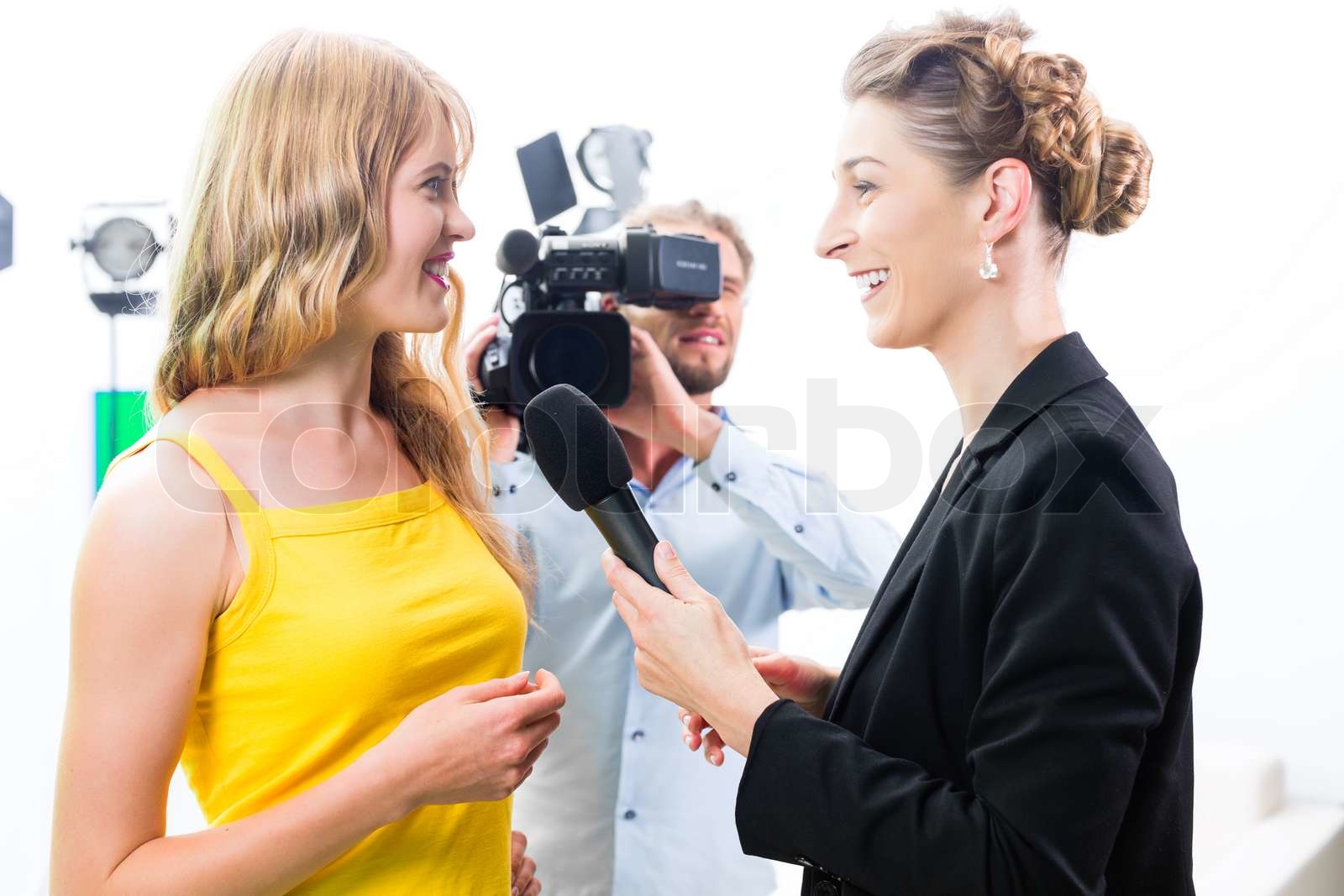 Reporter and cameraman shoot an interview | Stock image | Colourbox