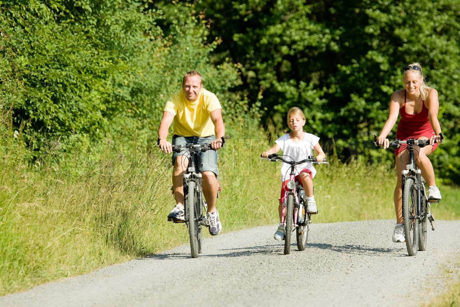 Family riding the bicycles together | Stock image | Colourbox