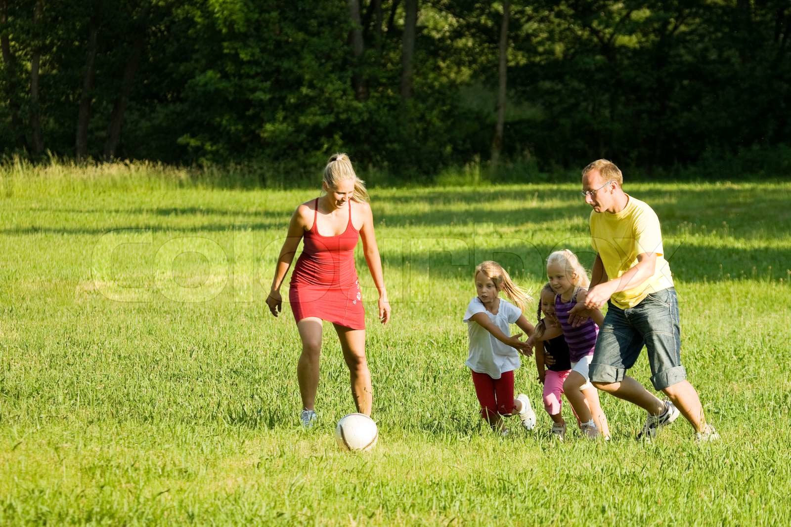 Family playing soccer | Stock image | Colourbox
