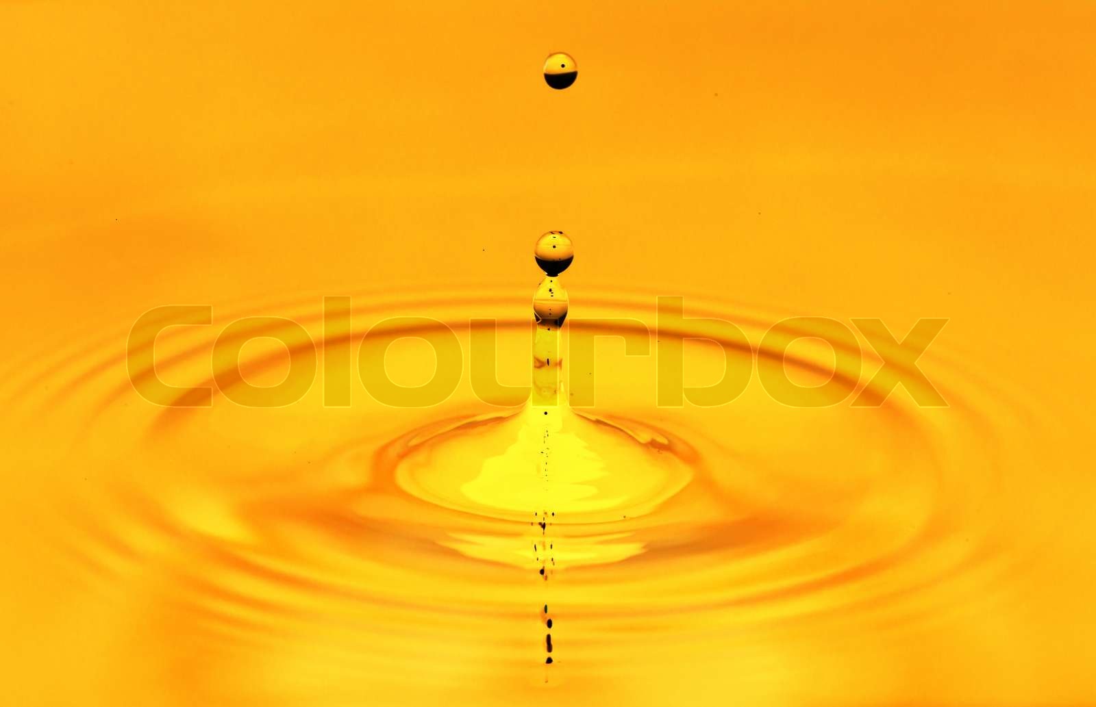 A drop of golden water. macro | Stock image | Colourbox