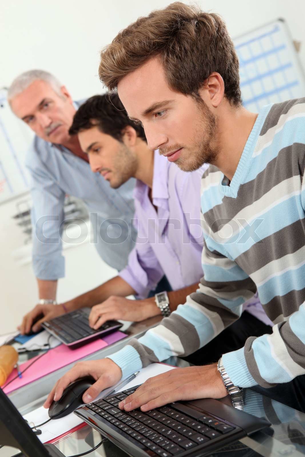 Young men using computers | Stock image | Colourbox