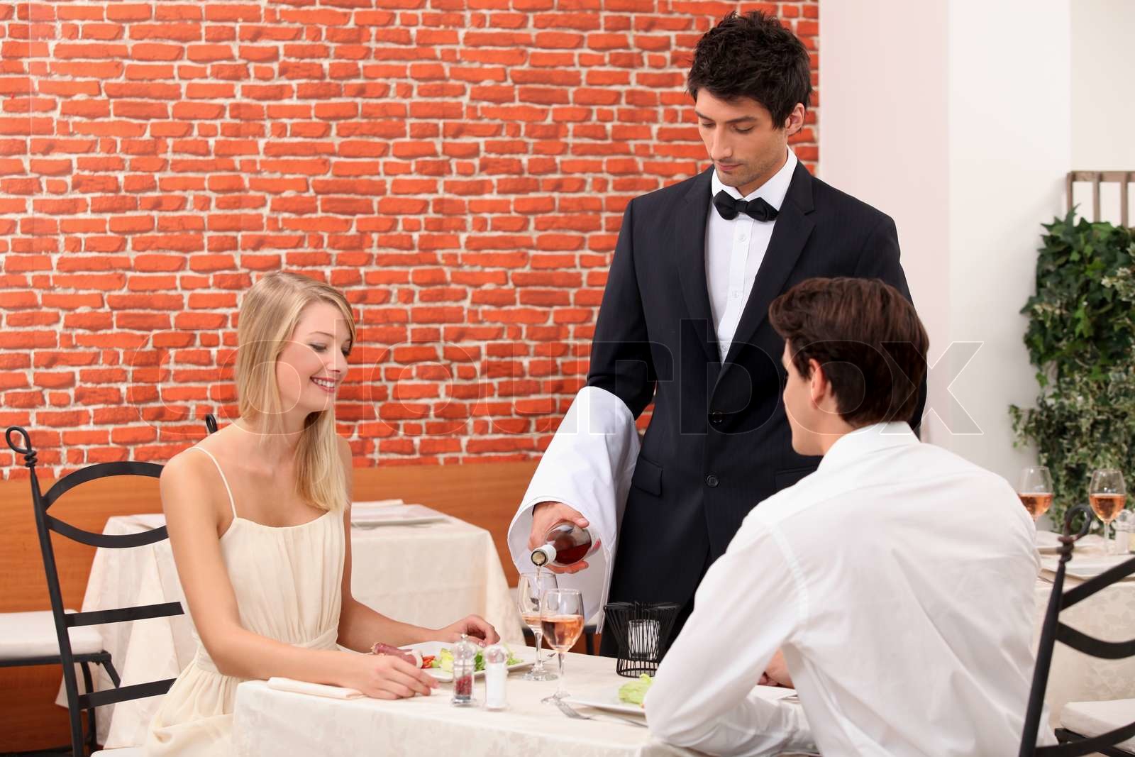 waiter serving couple | Stock image | Colourbox