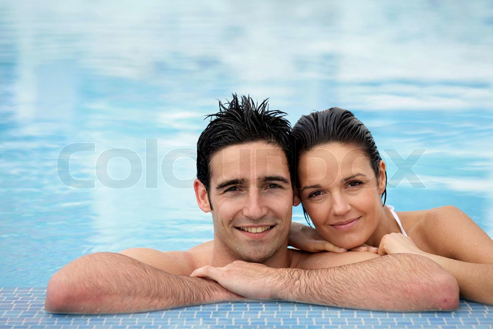 Couple stood together in swimming pool | Stock image | Colourbox