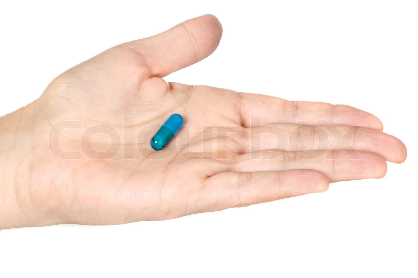 Hand with a pill | Stock image | Colourbox