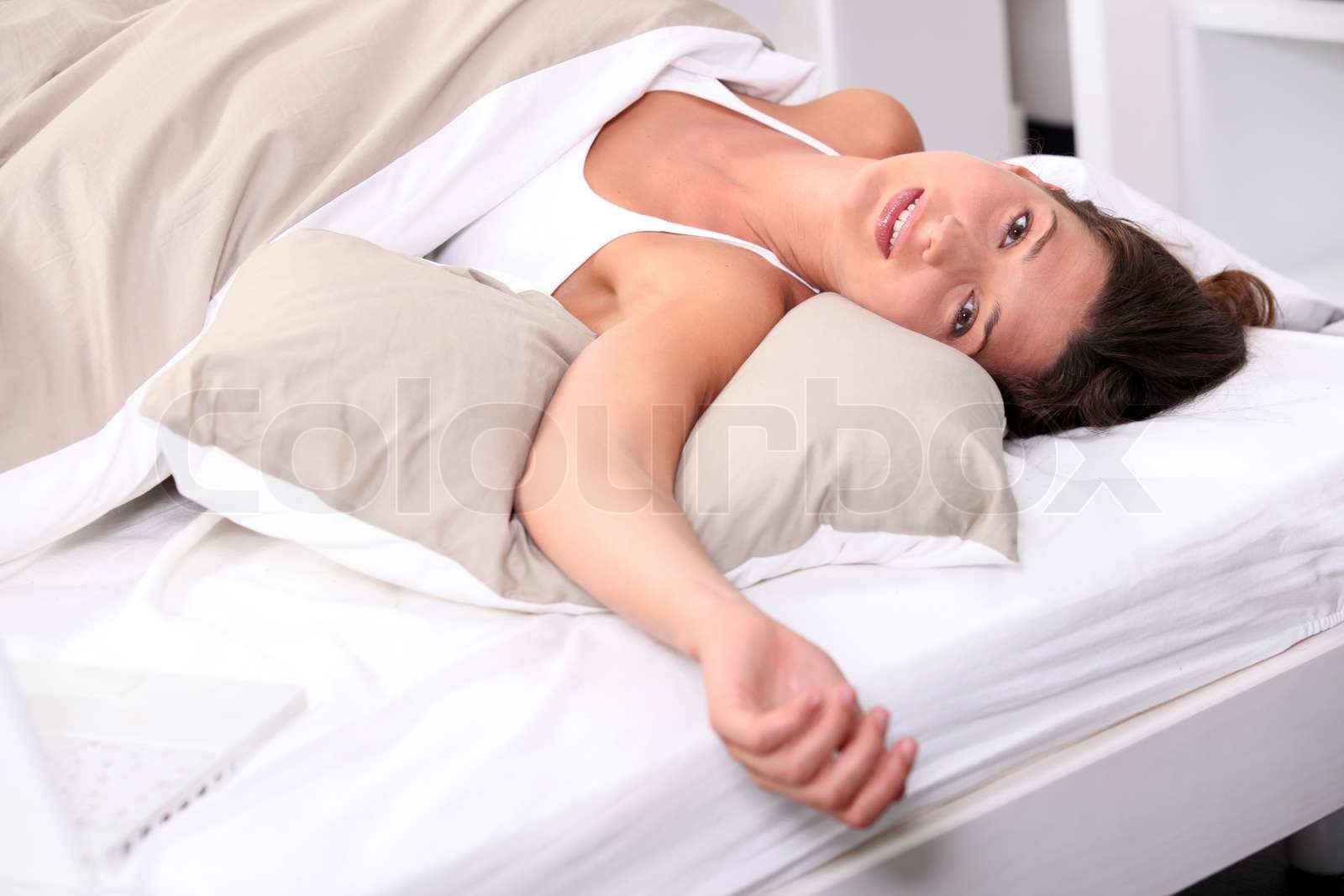 Woman sprawled in bed | Stock image | Colourbox