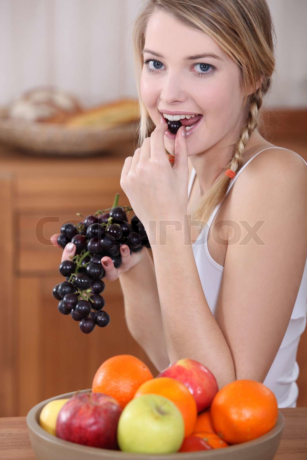 Woman eating fruit | Stock image | Colourbox