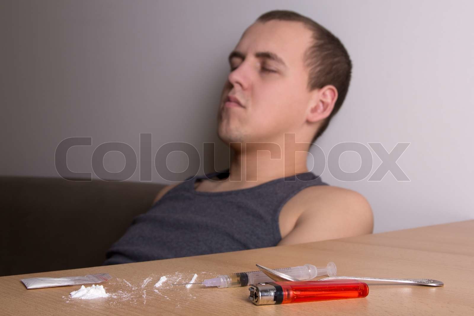 addicted man with drugs on the table | Stock image | Colourbox