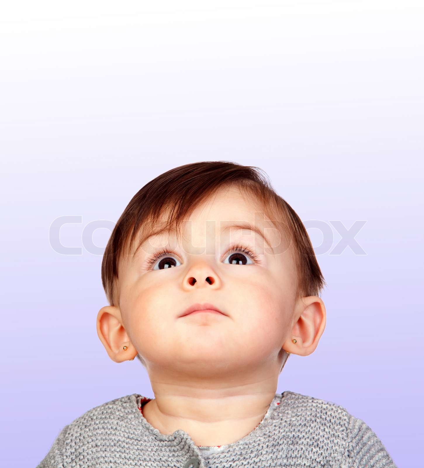 Surprised baby girl looking up | Stock image | Colourbox