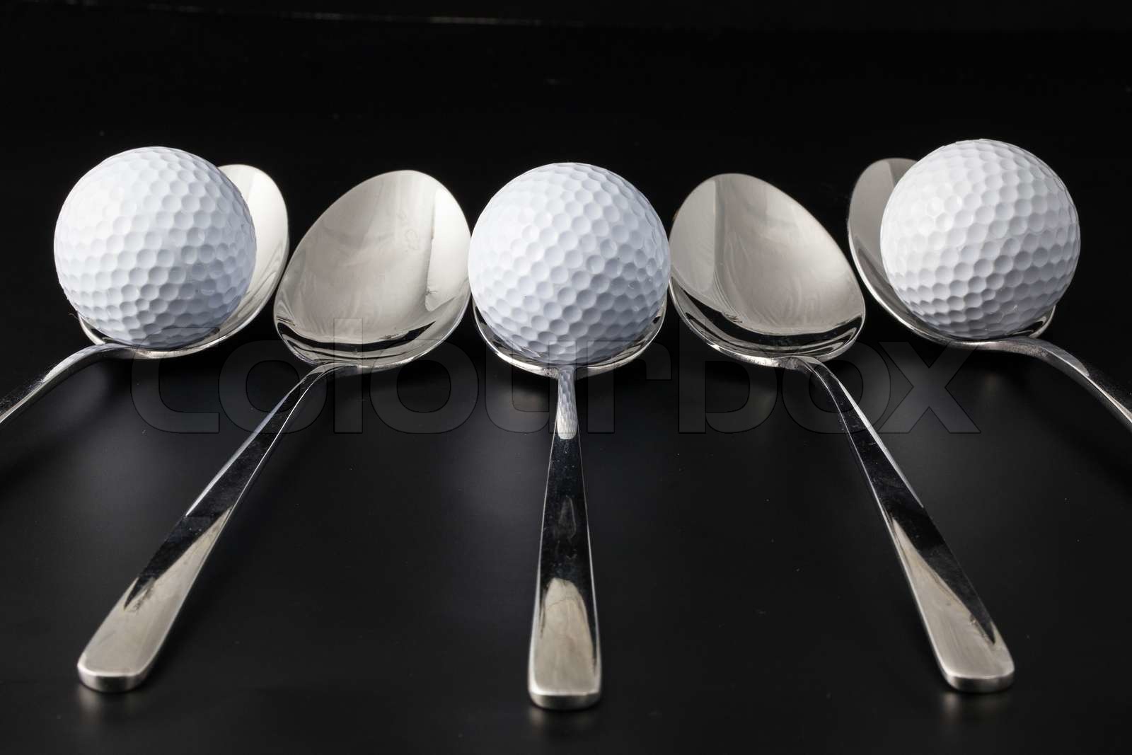 Spoons and golf balls | Stock image | Colourbox