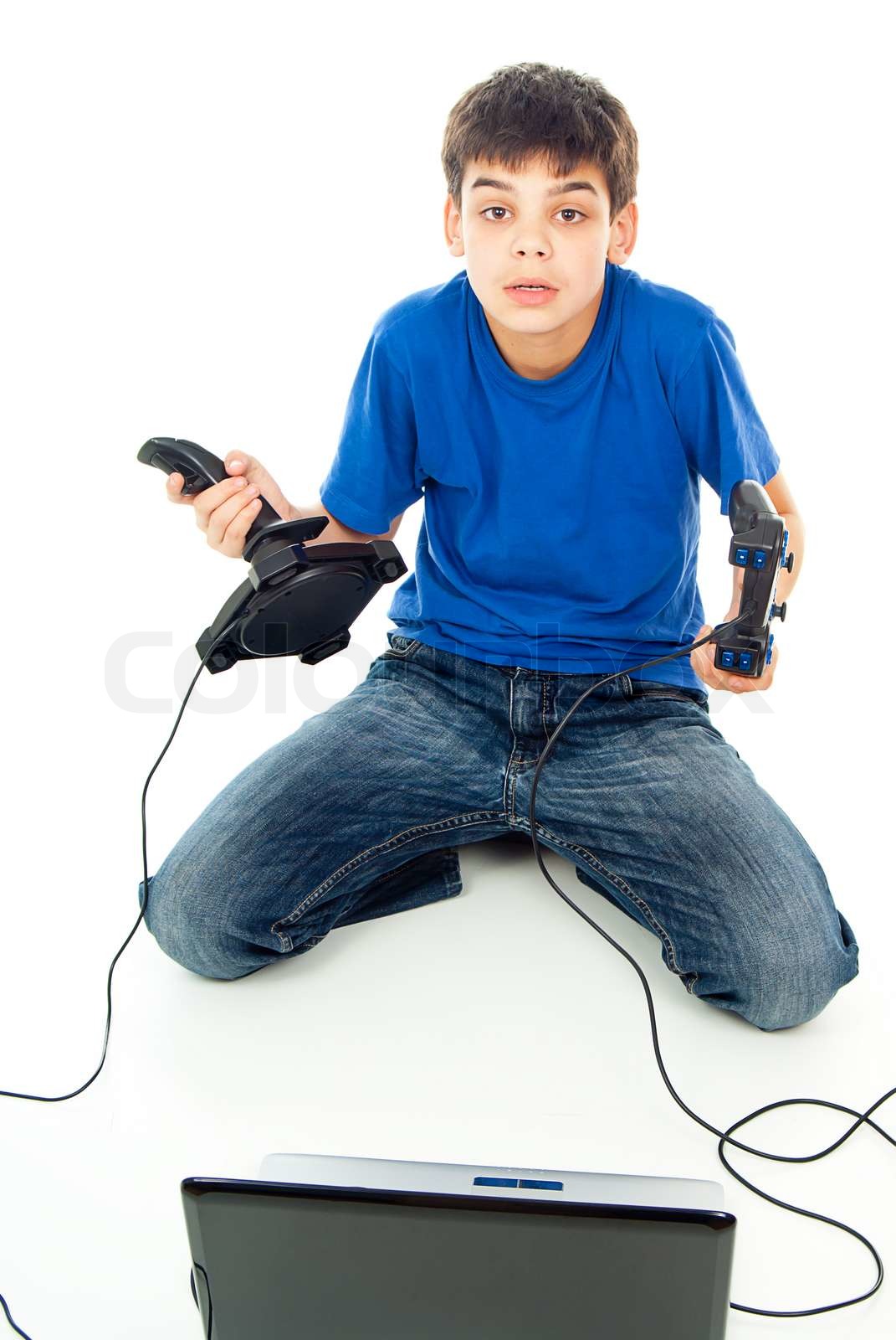 boy sitting with a computer and joystick | Stock image | Colourbox